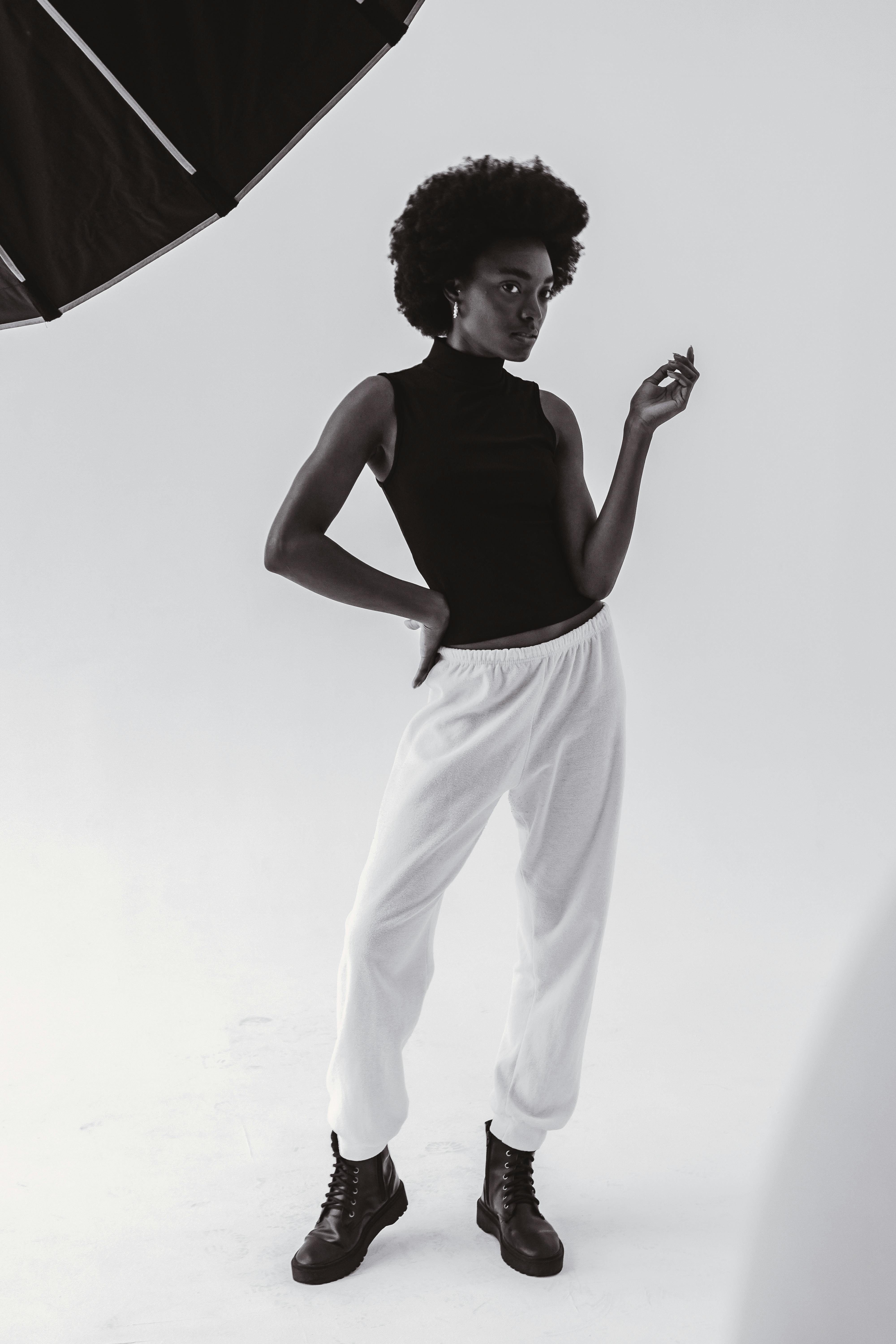 Young Woman Posing in Studio in a Simple Outfit · Free Stock Photo