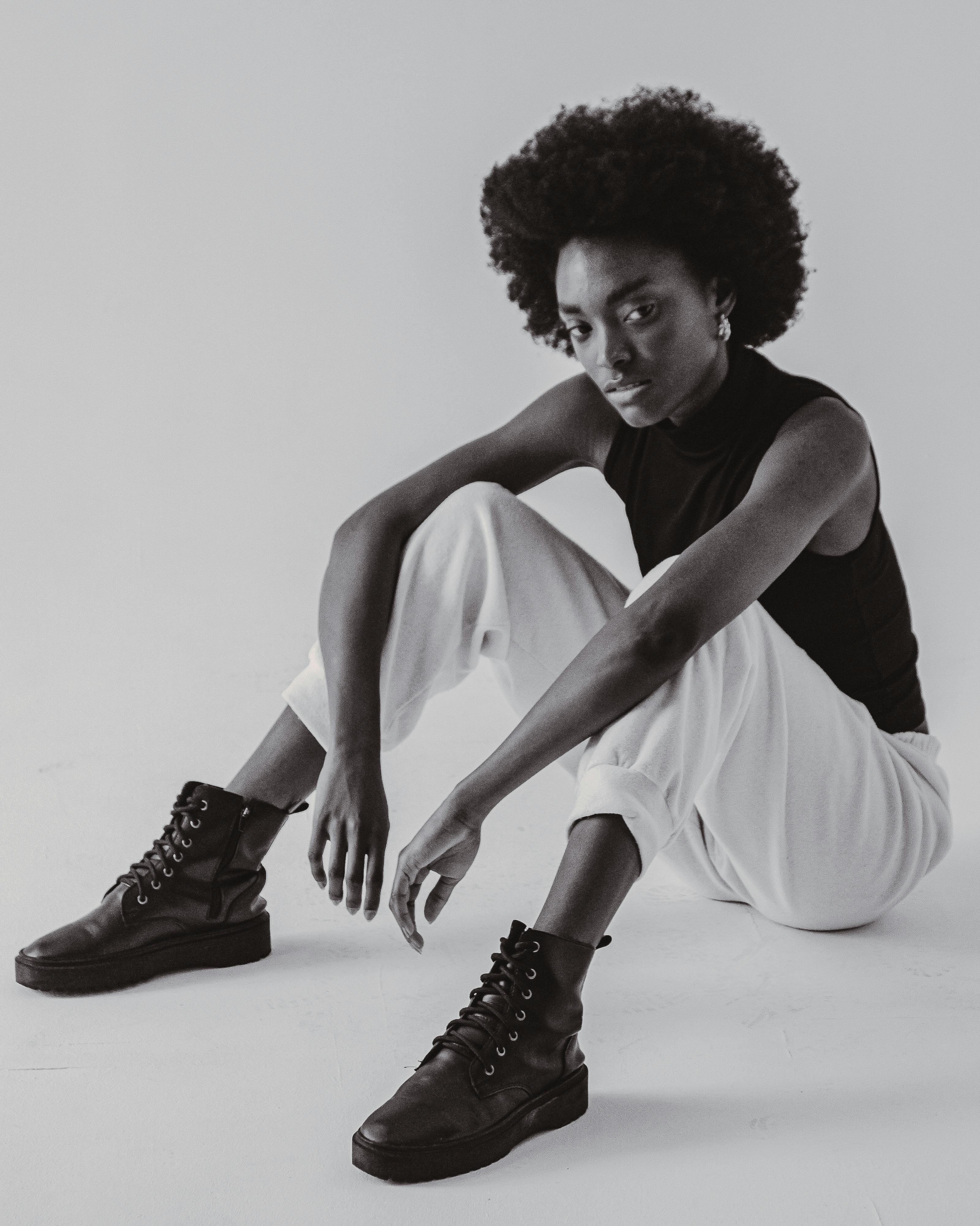 Young Woman Posing in Studio in a Simple Outfit · Free Stock Photo