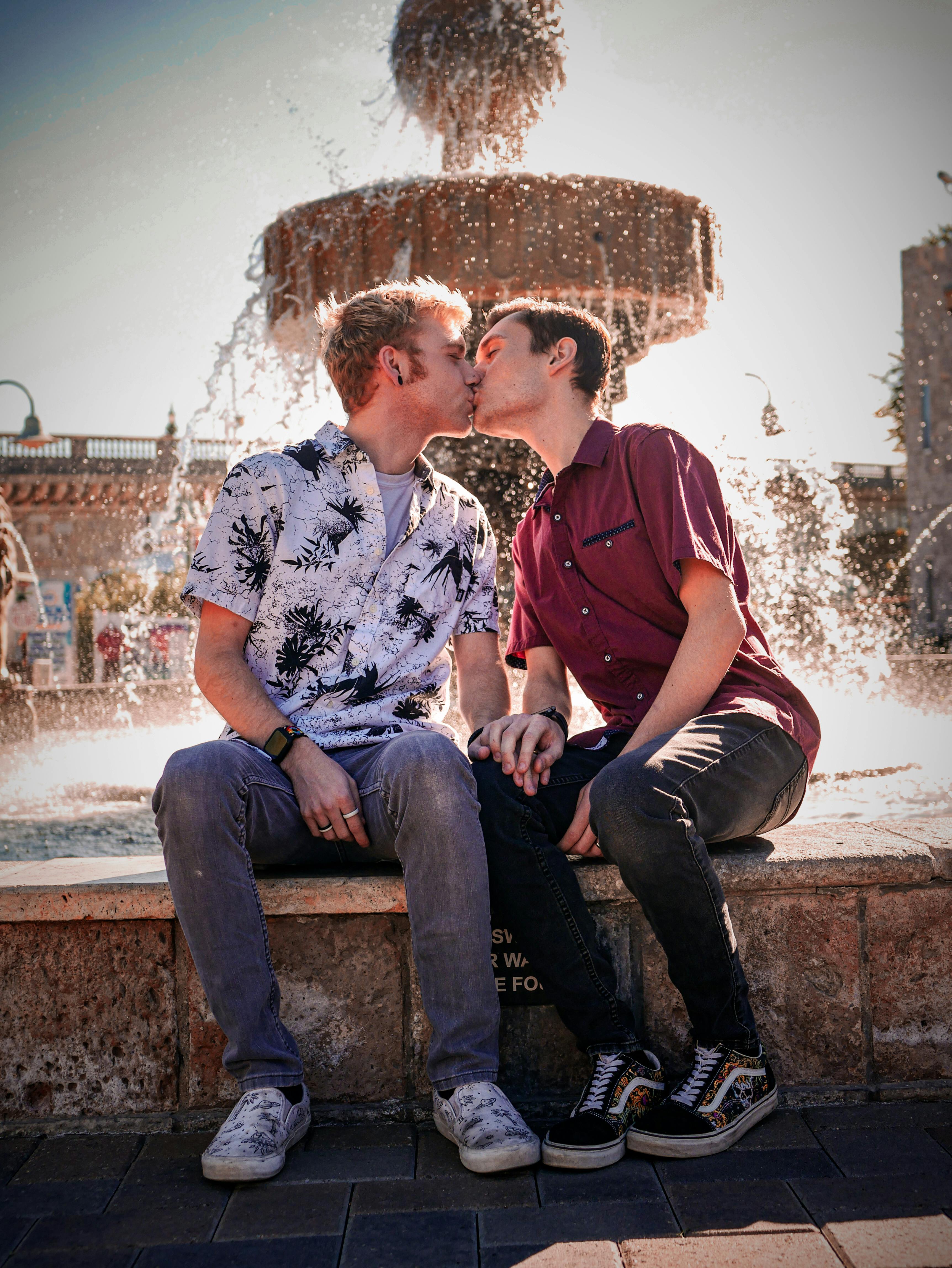 Two Men Posing Beside a Metal Grill While Holding Each Other · Free ...