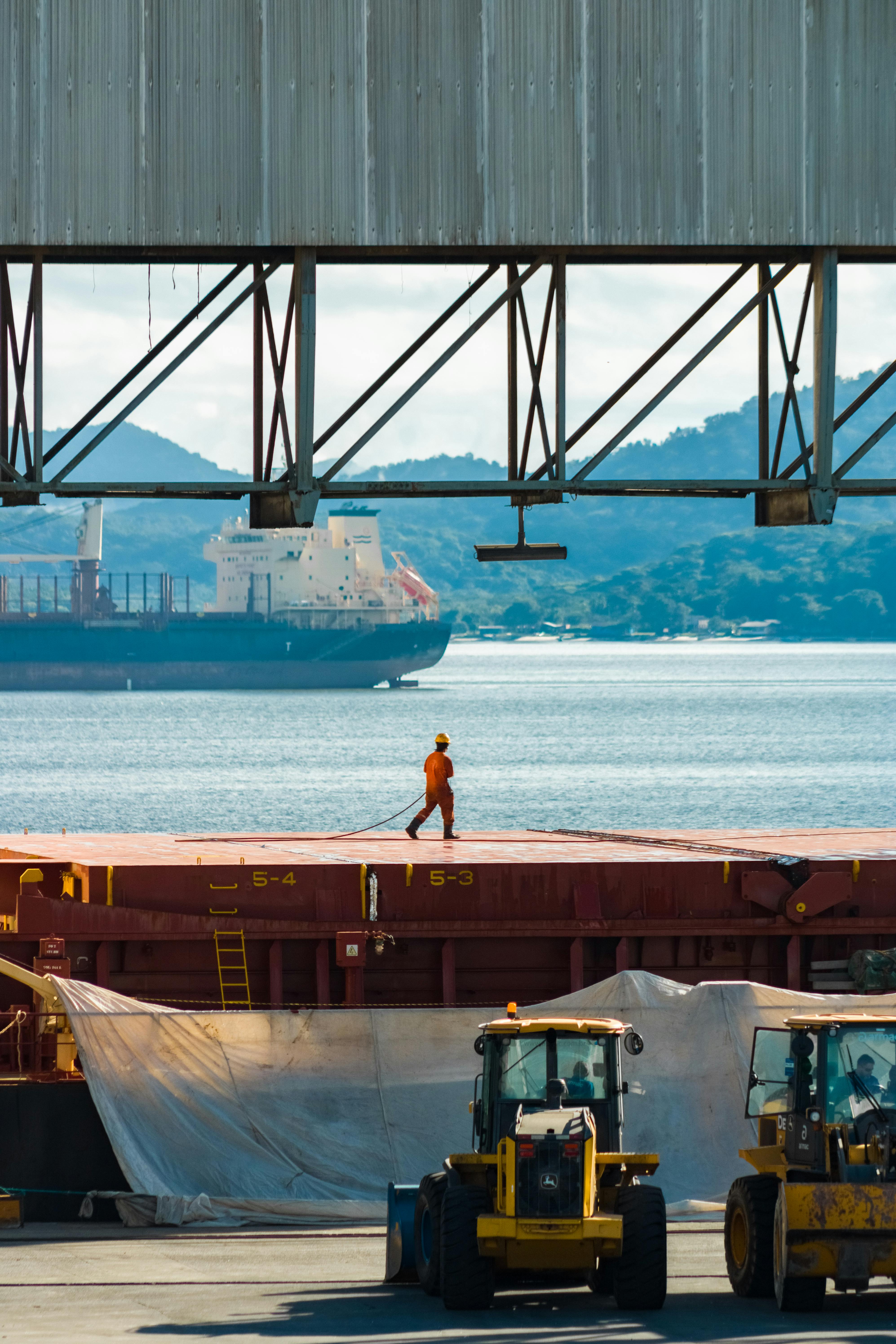 Man Walking on a Platform in a Port · Free Stock Photo