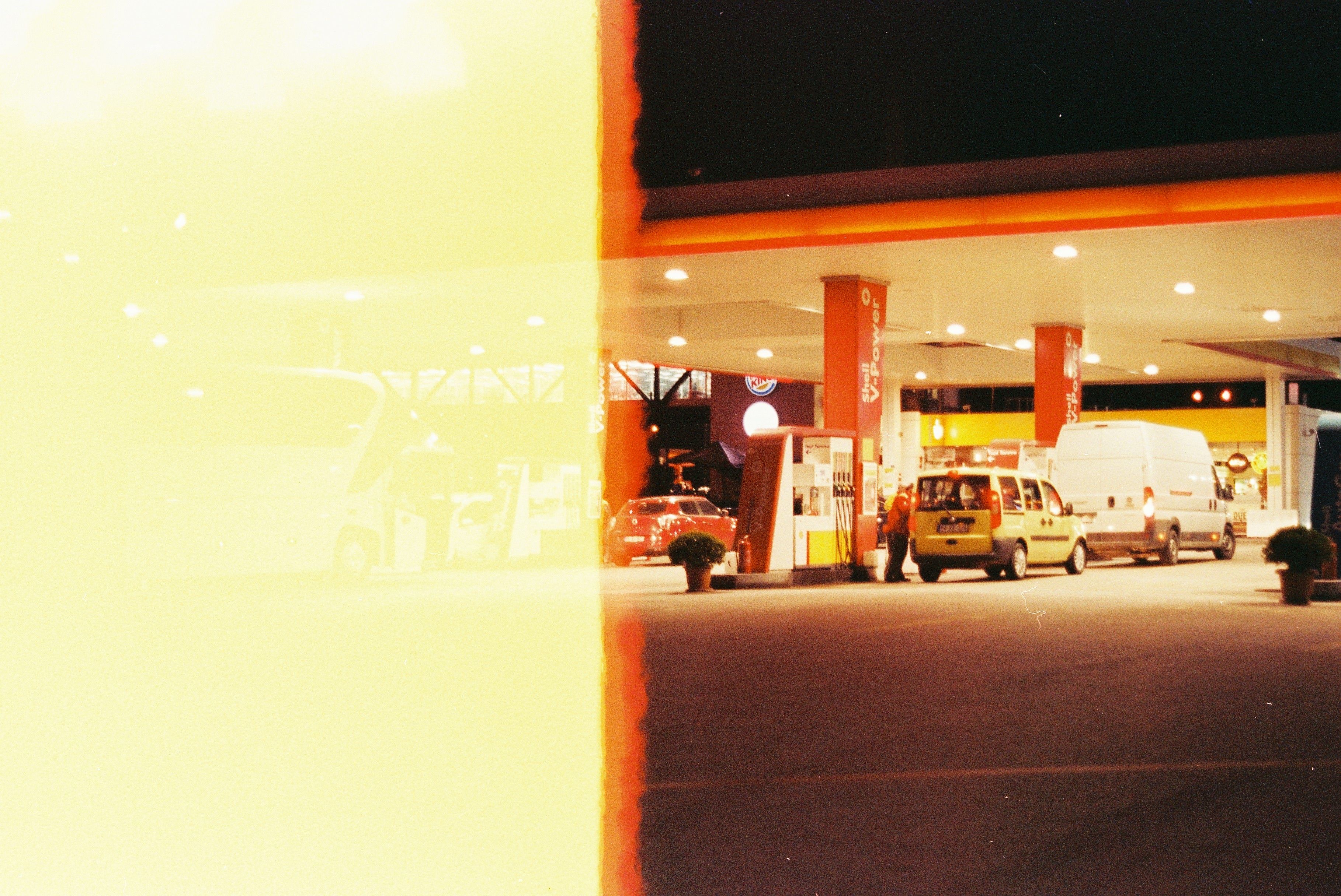 Film Photograph of Cars at a Gas Station · Free Stock Photo