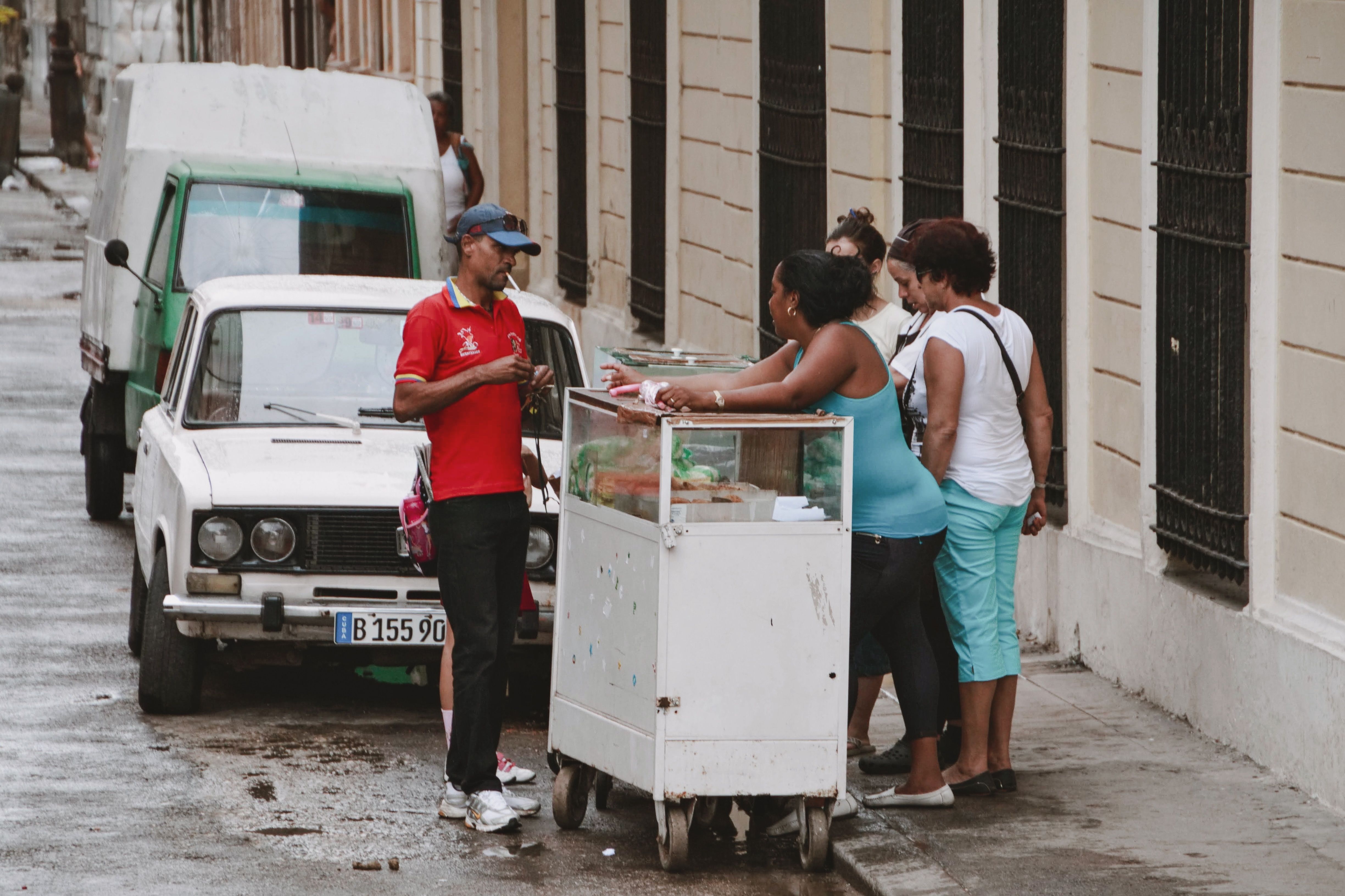 A Group of People Standing on the Street and Talking · Free Stock Photo