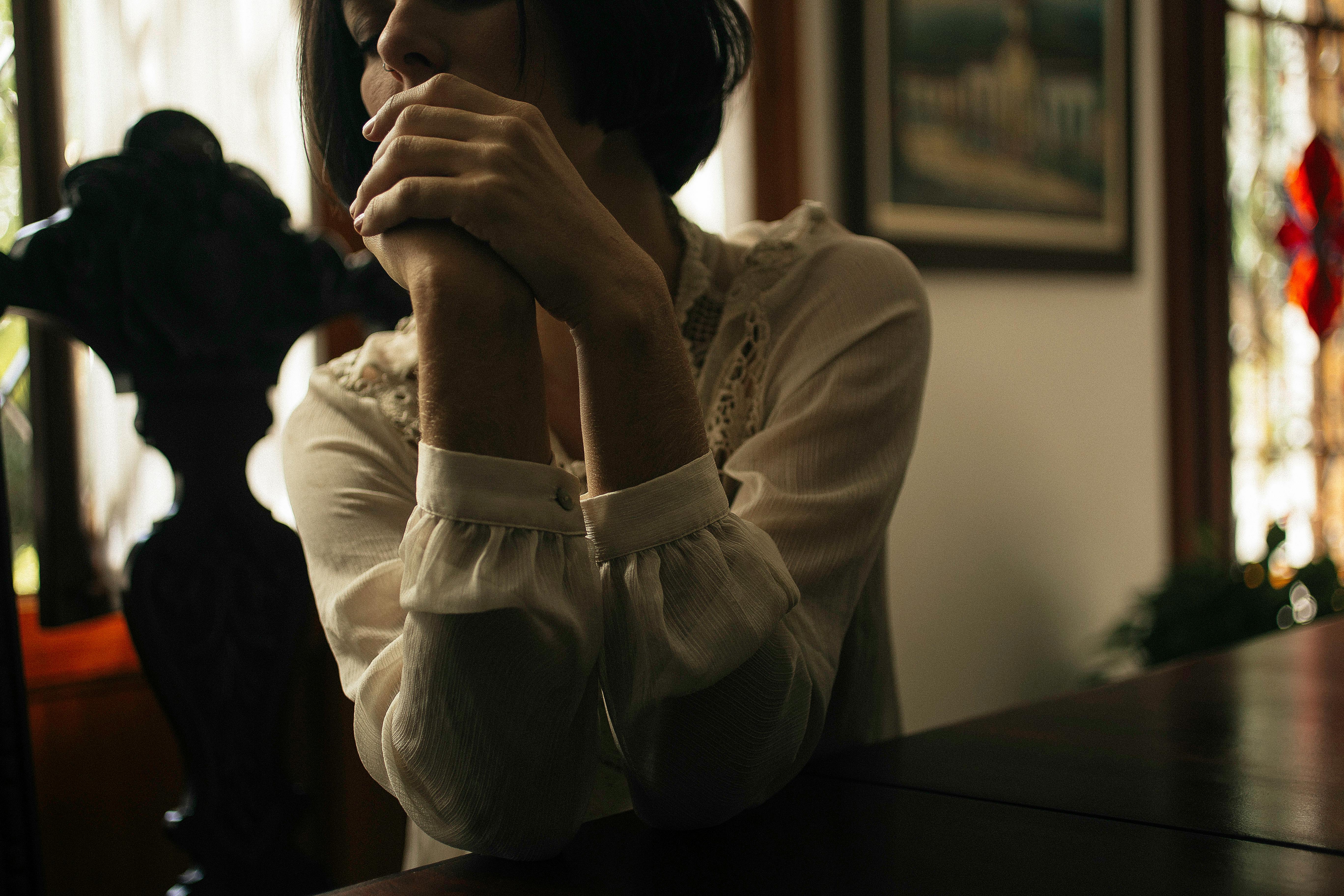 A Woman Sitting at a Table · Free Stock Photo