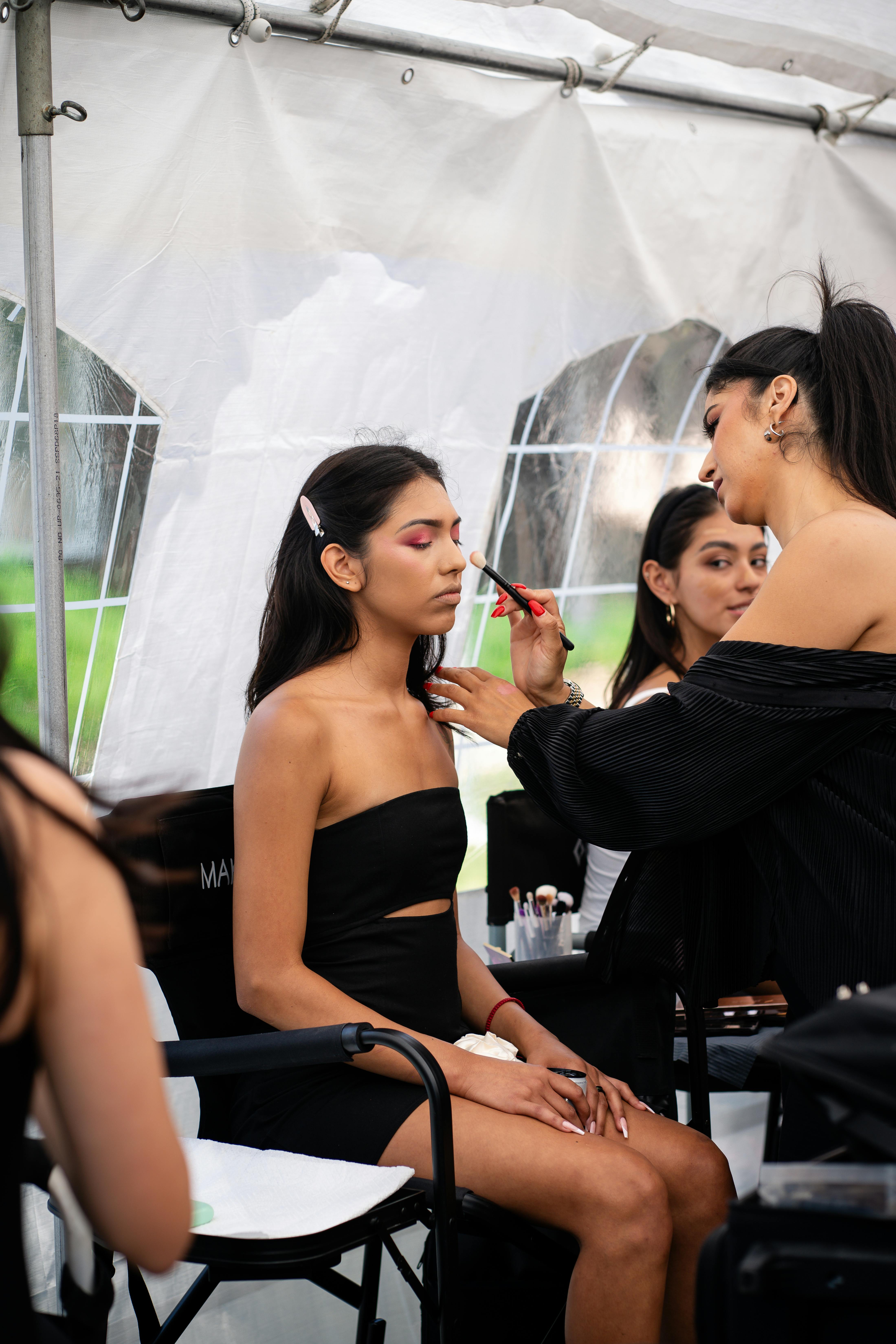 Women Getting Makeup inn a White Tent · Free Stock Photo