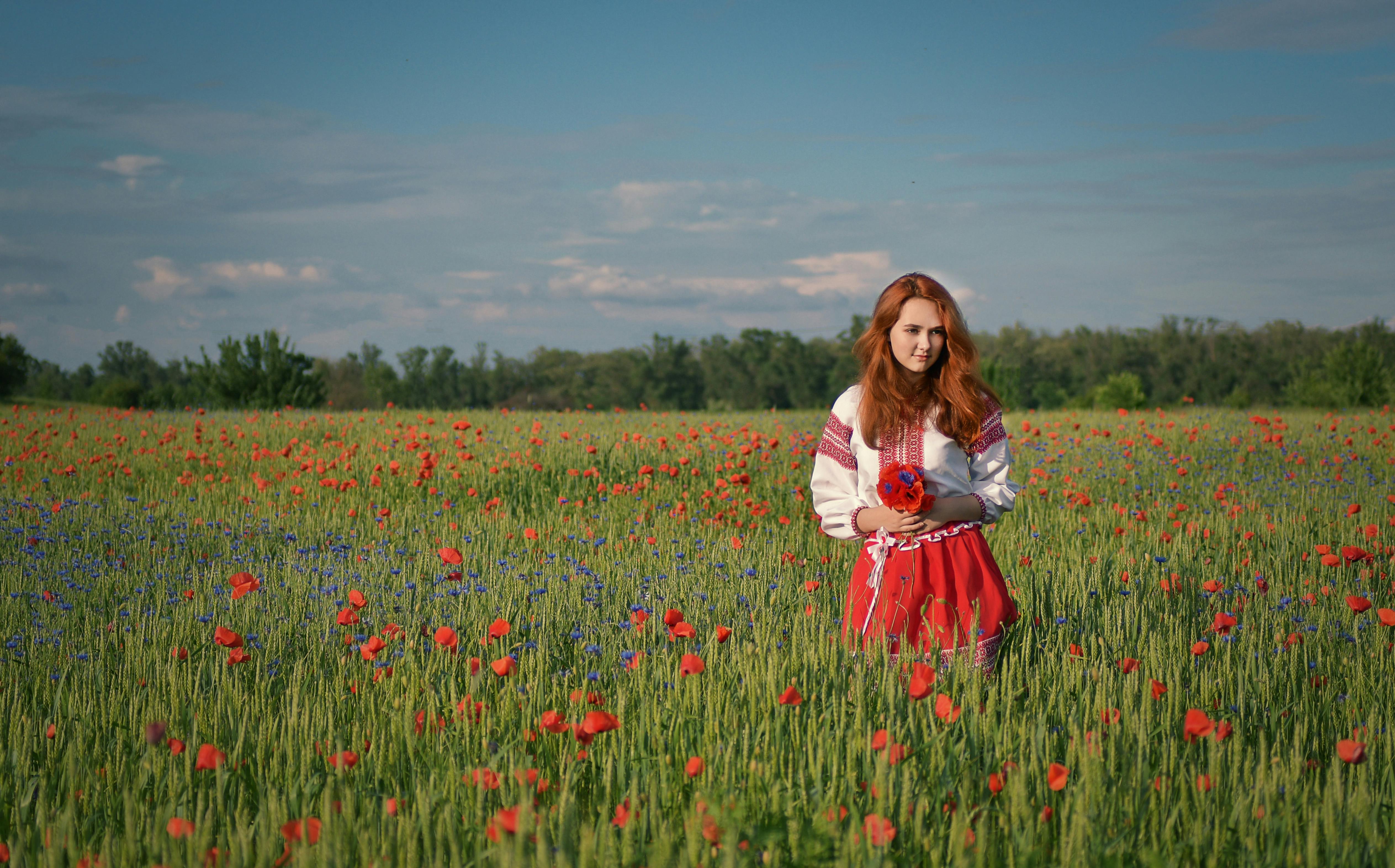Redhead Girl Wearing a Red Skirt Standing in a Poppy Field · Free Stock ...