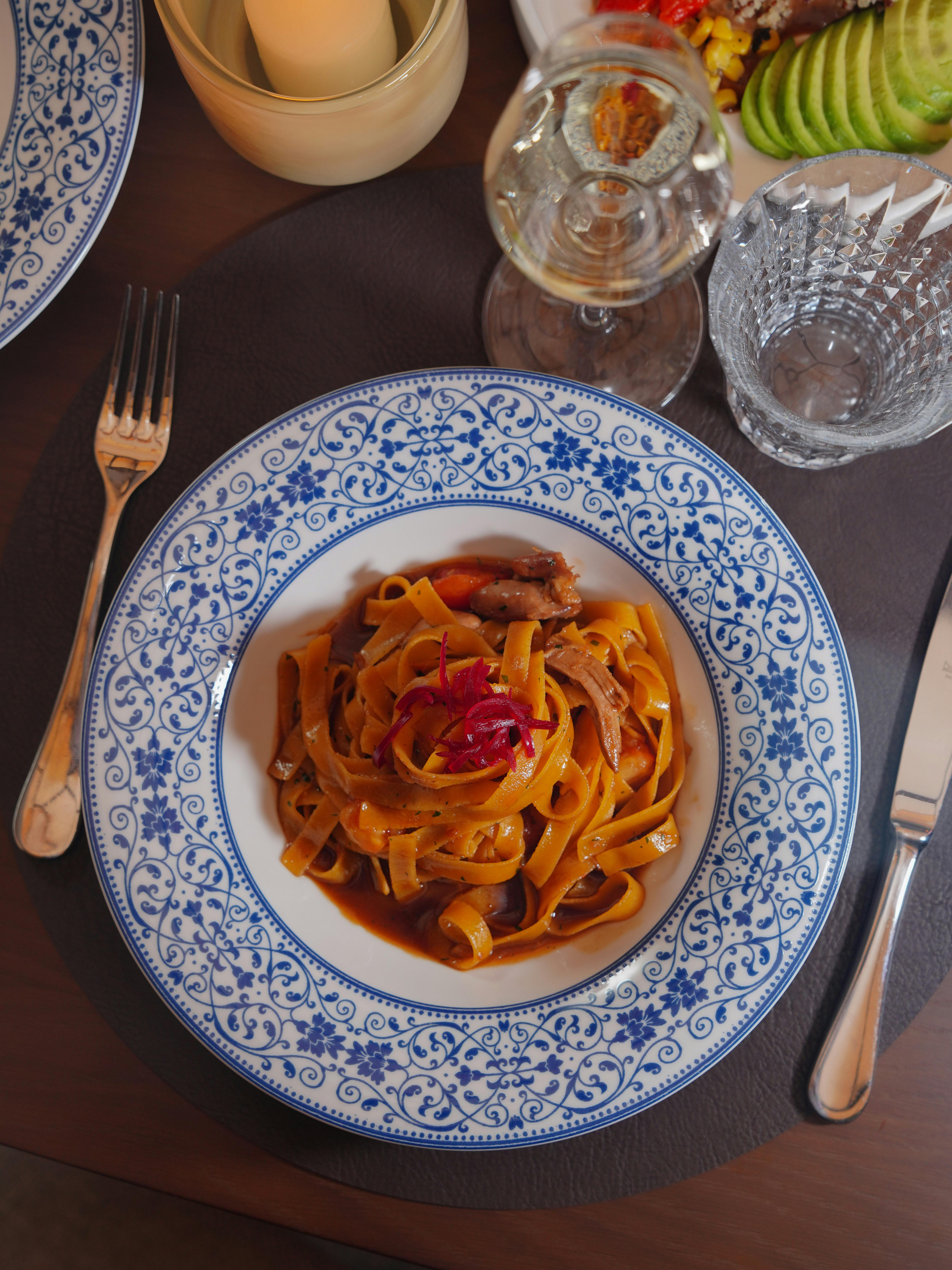Pasta with flowers laying on plate · Free Stock Photo