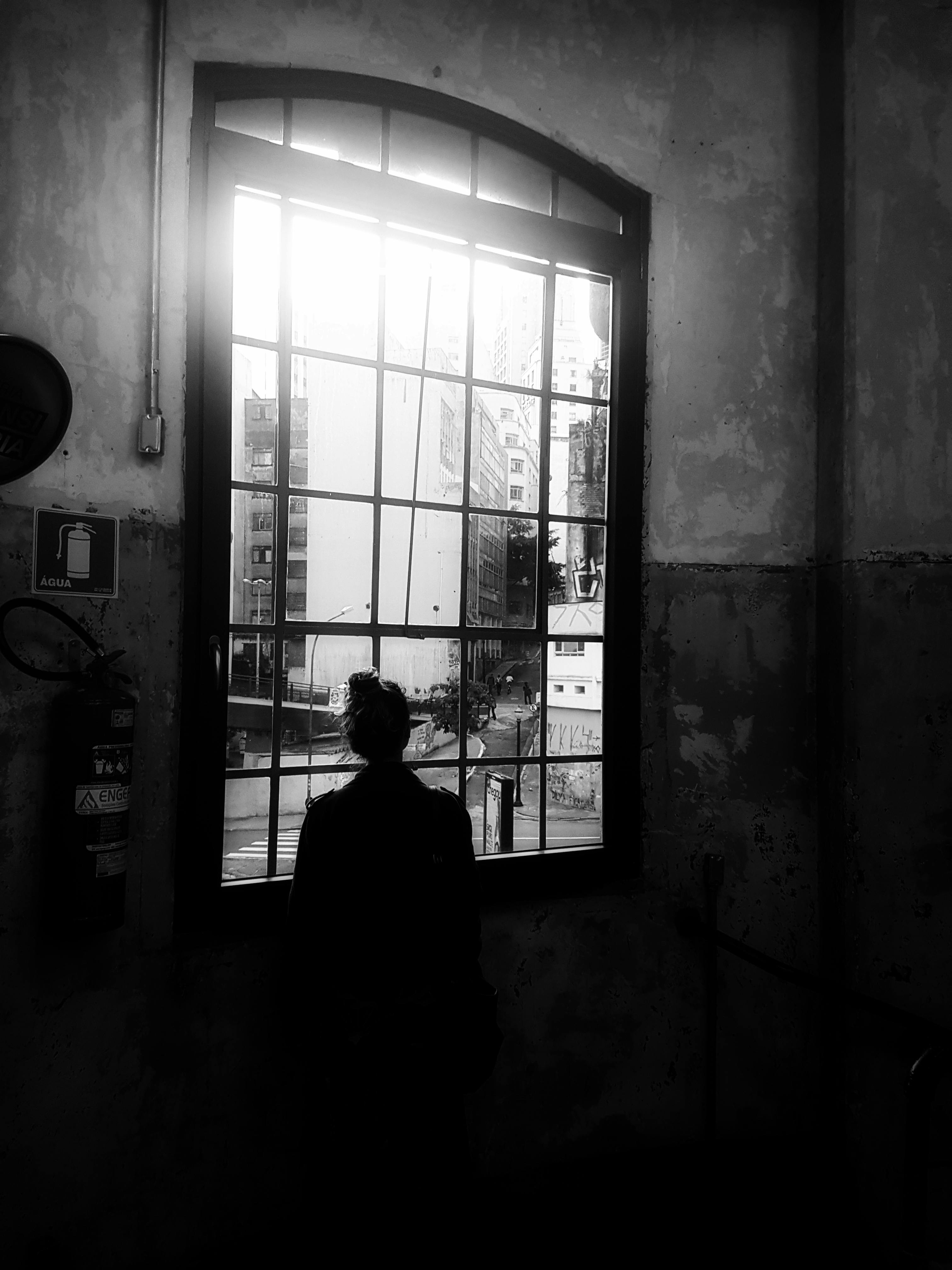 Woman Standing Beside Window · Free Stock Photo