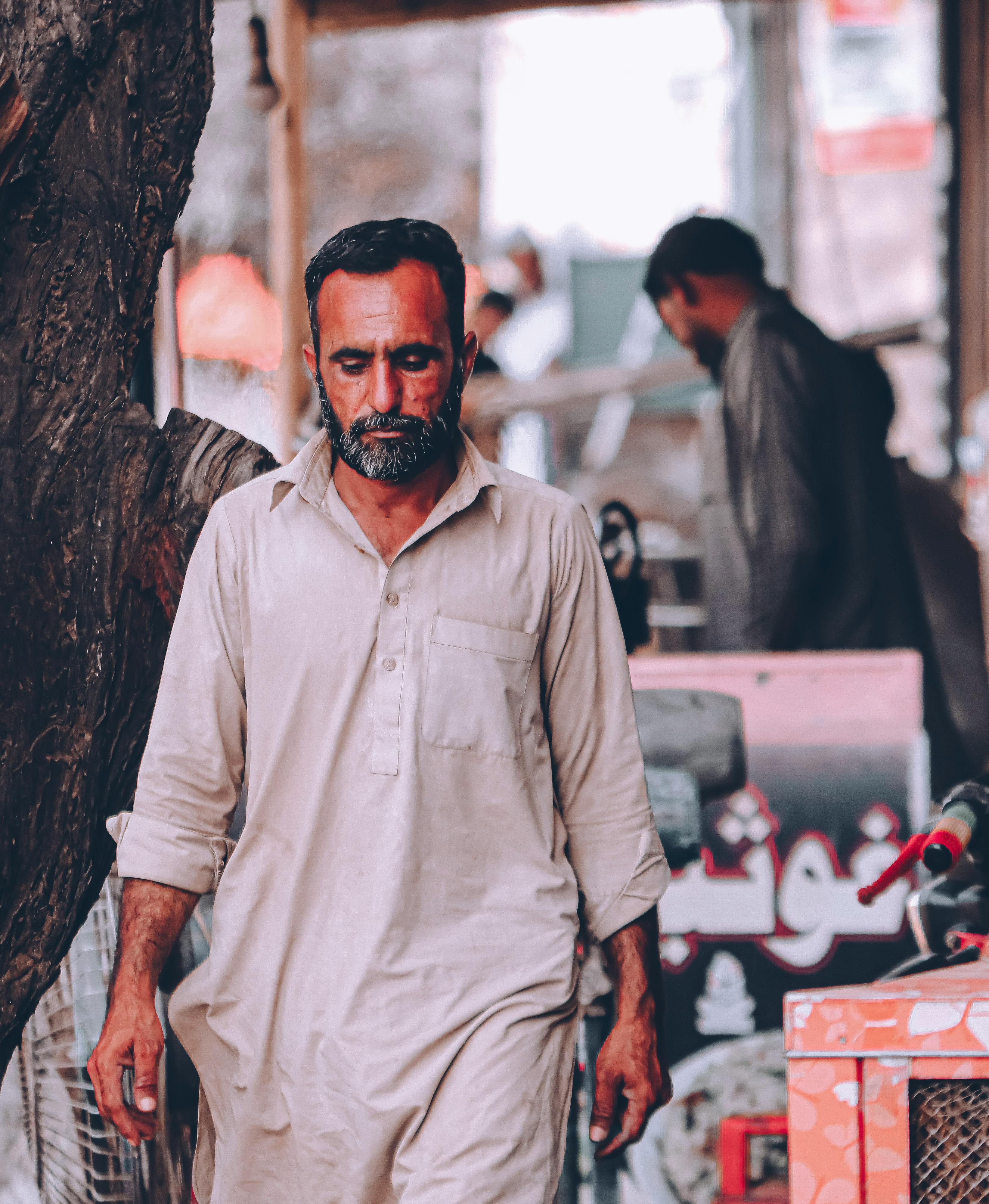 A man walking down a street in pakistan · Free Stock Photo