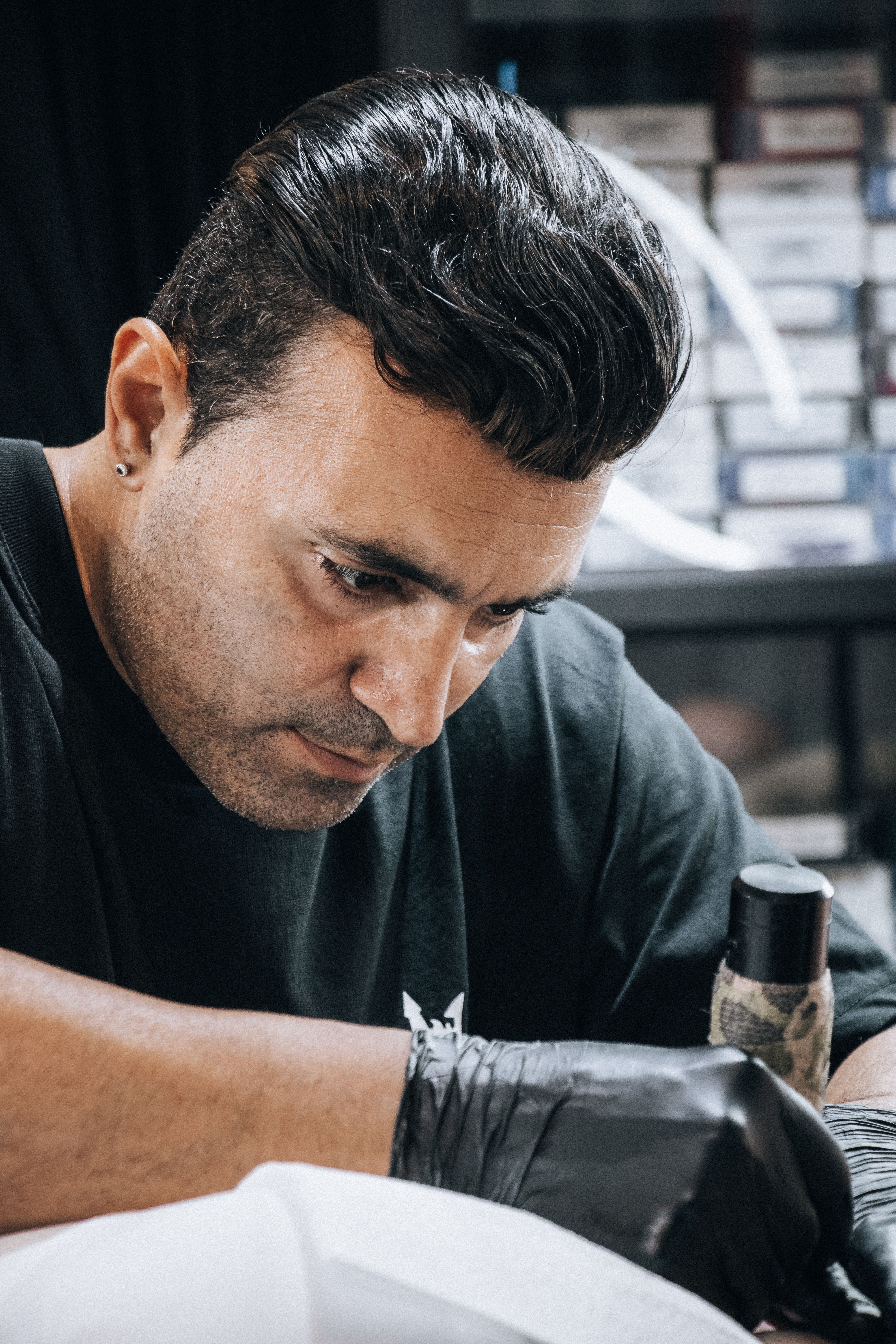 Tattooist Focused during Work · Free Stock Photo