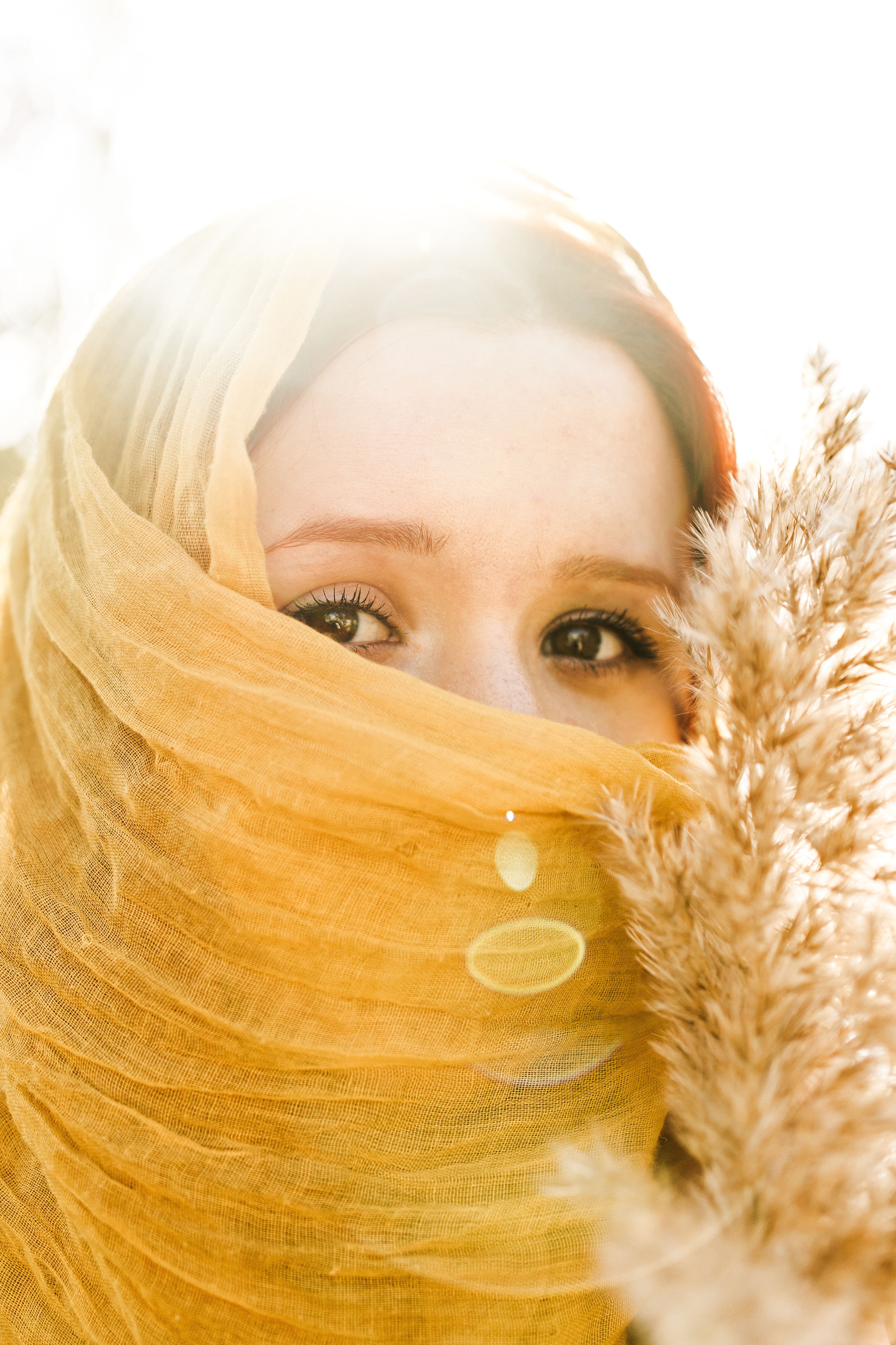 A woman with a yellow scarf covering her face · Free Stock Photo