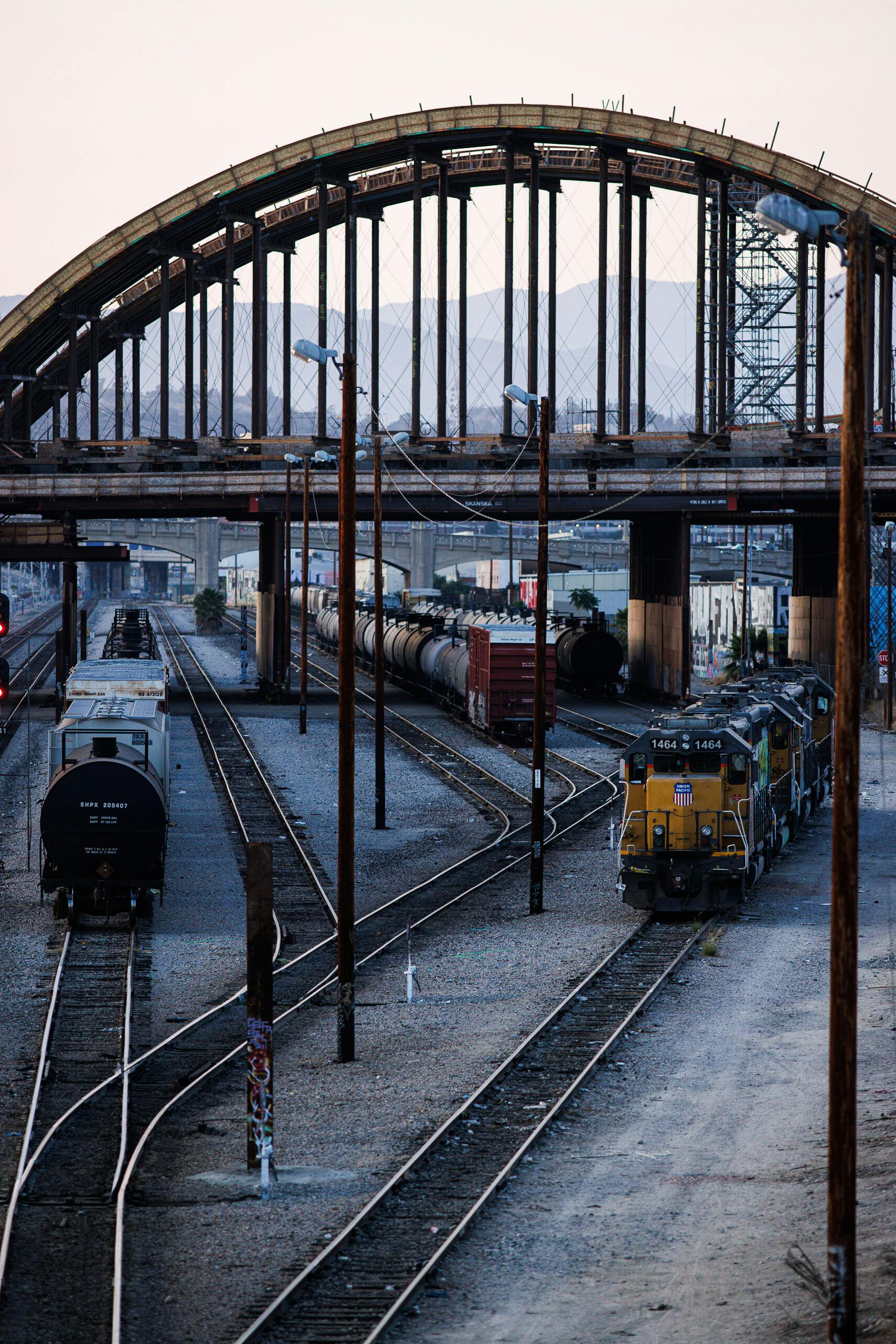 Cargo Trains on Tracks under Bridge · Free Stock Photo