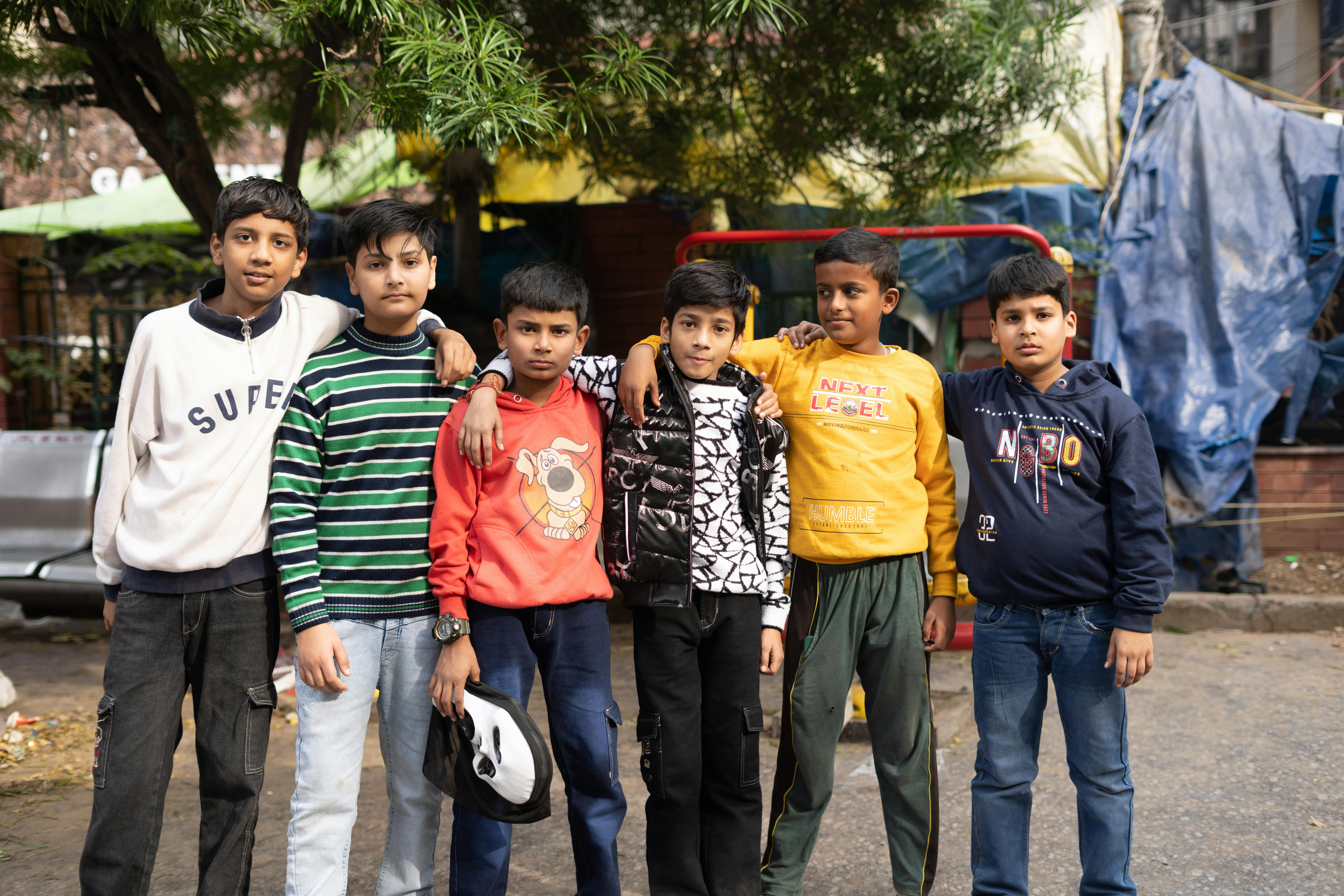 Photo of a Group of Young Boys Standing on a Street · Free Stock Photo