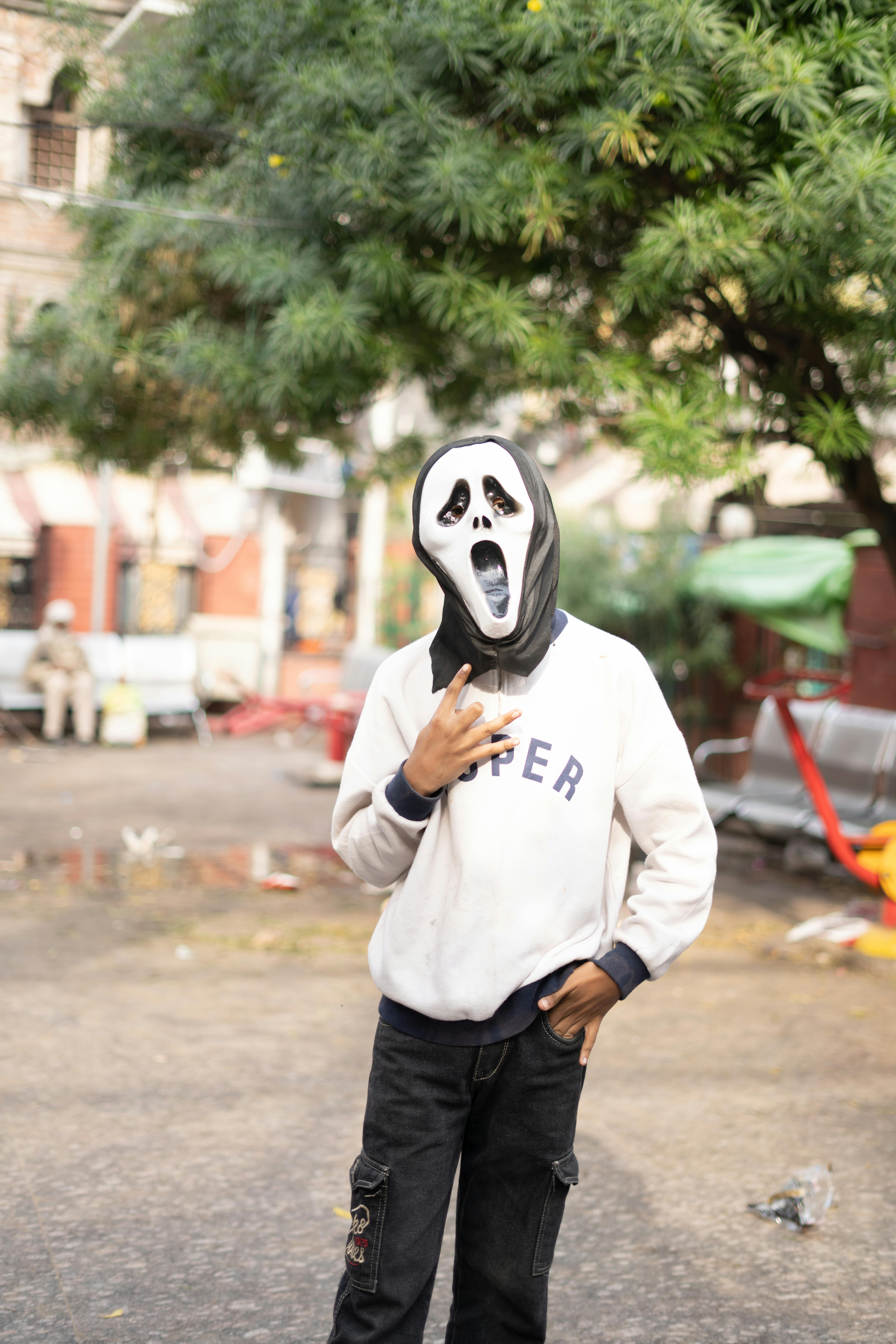 Person Wearing Scream Mask and Black Dress Shirt While Facing Computer ...