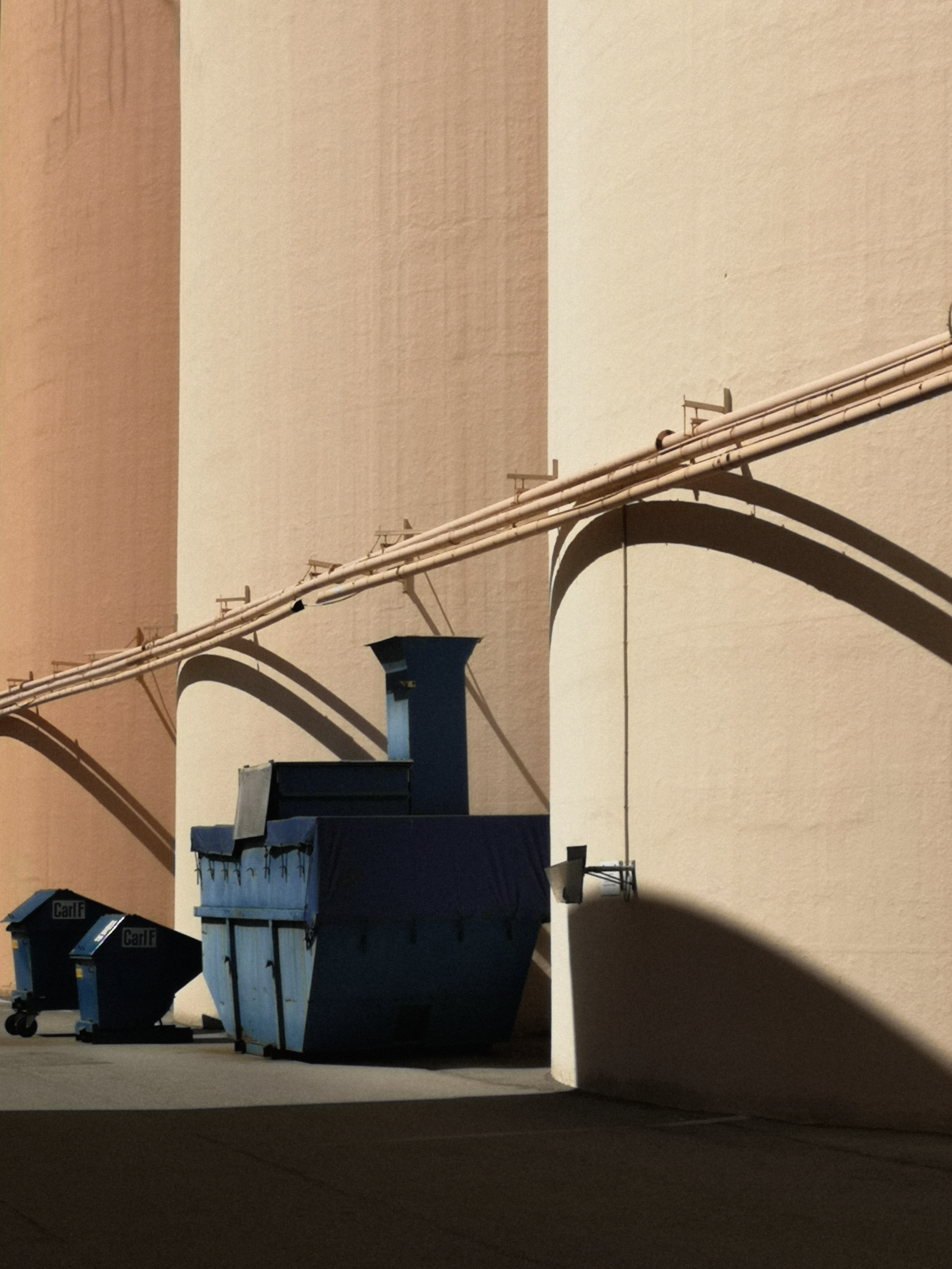Garbage Containers by a Wall of Factory · Free Stock Photo