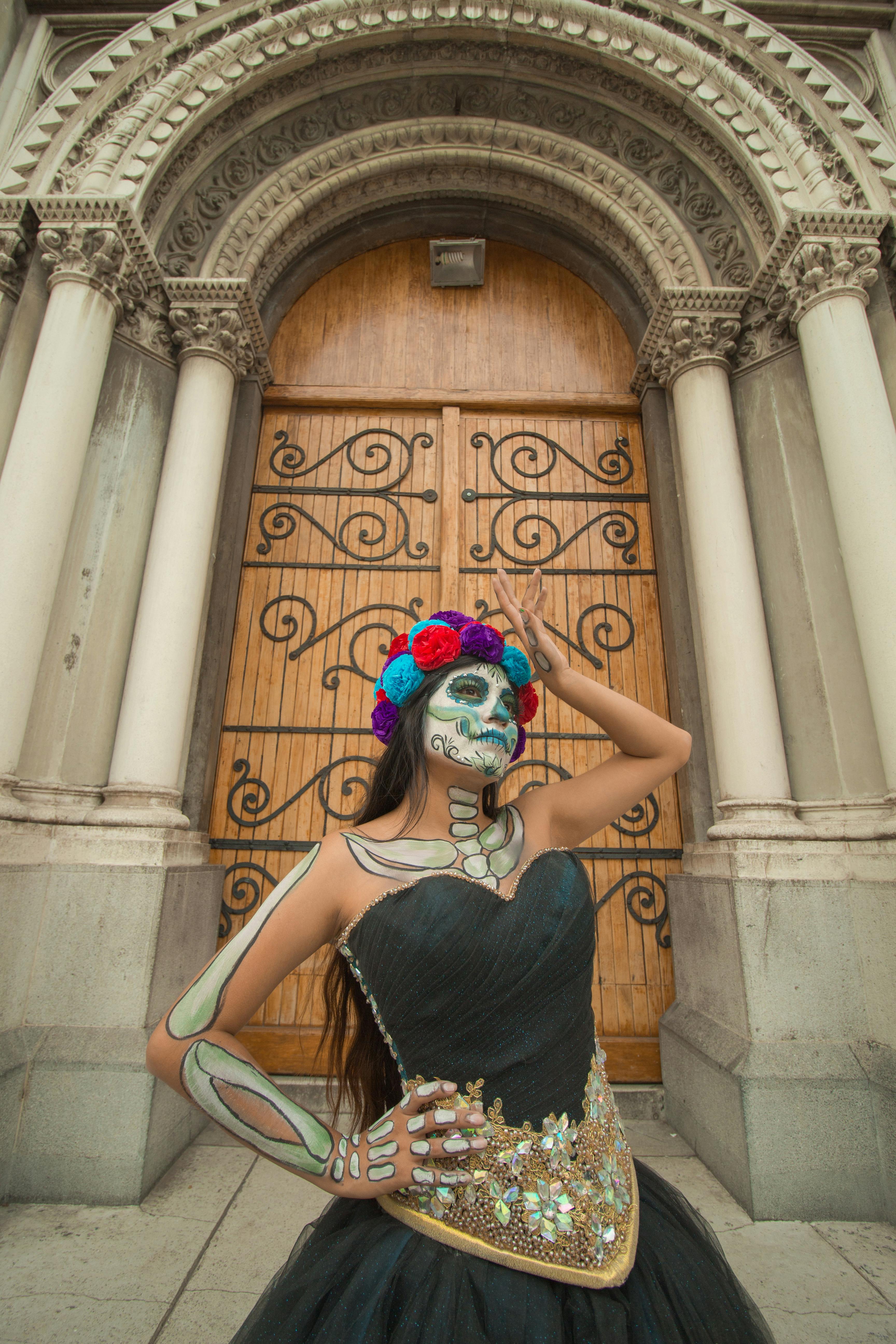Woman Dressed as a Catrina Posing in Front of a Building · Free Stock Photo