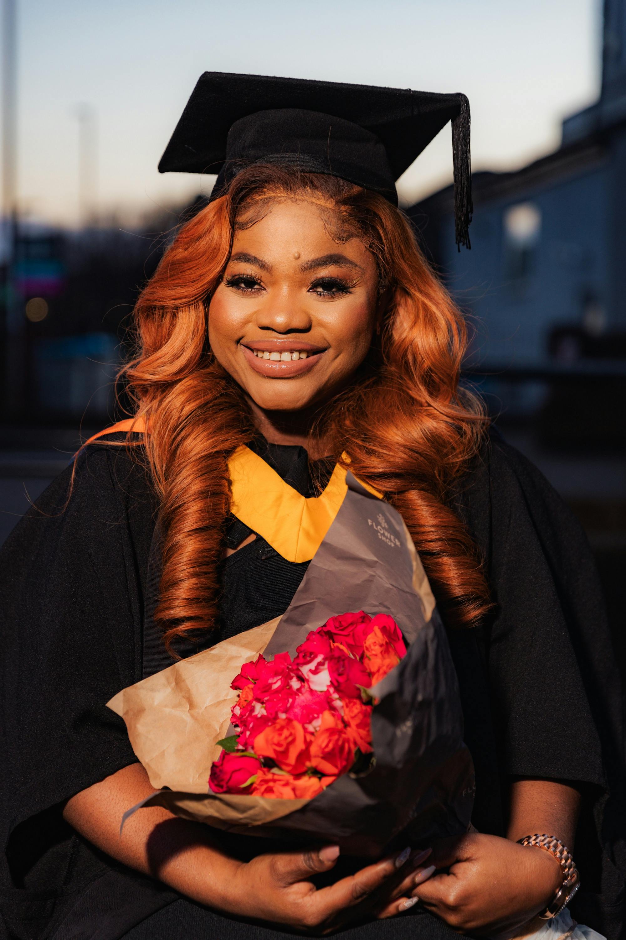 A Graduate Wearing a Mortarboard and a Graduation Gown · Free Stock Photo
