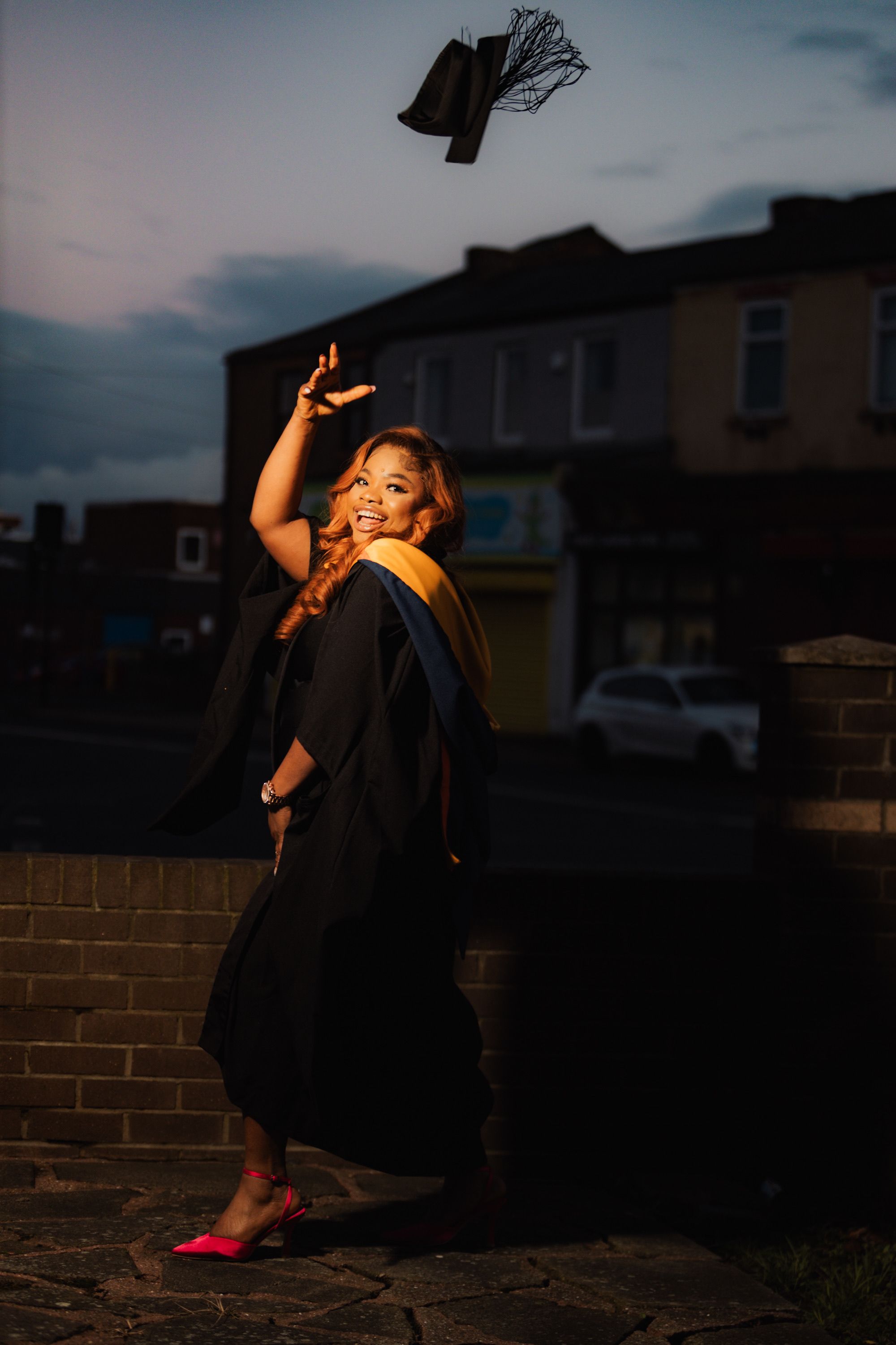 Photo of a Smiling Woman Wearing a Navy Blue Graduation Gown and High ...