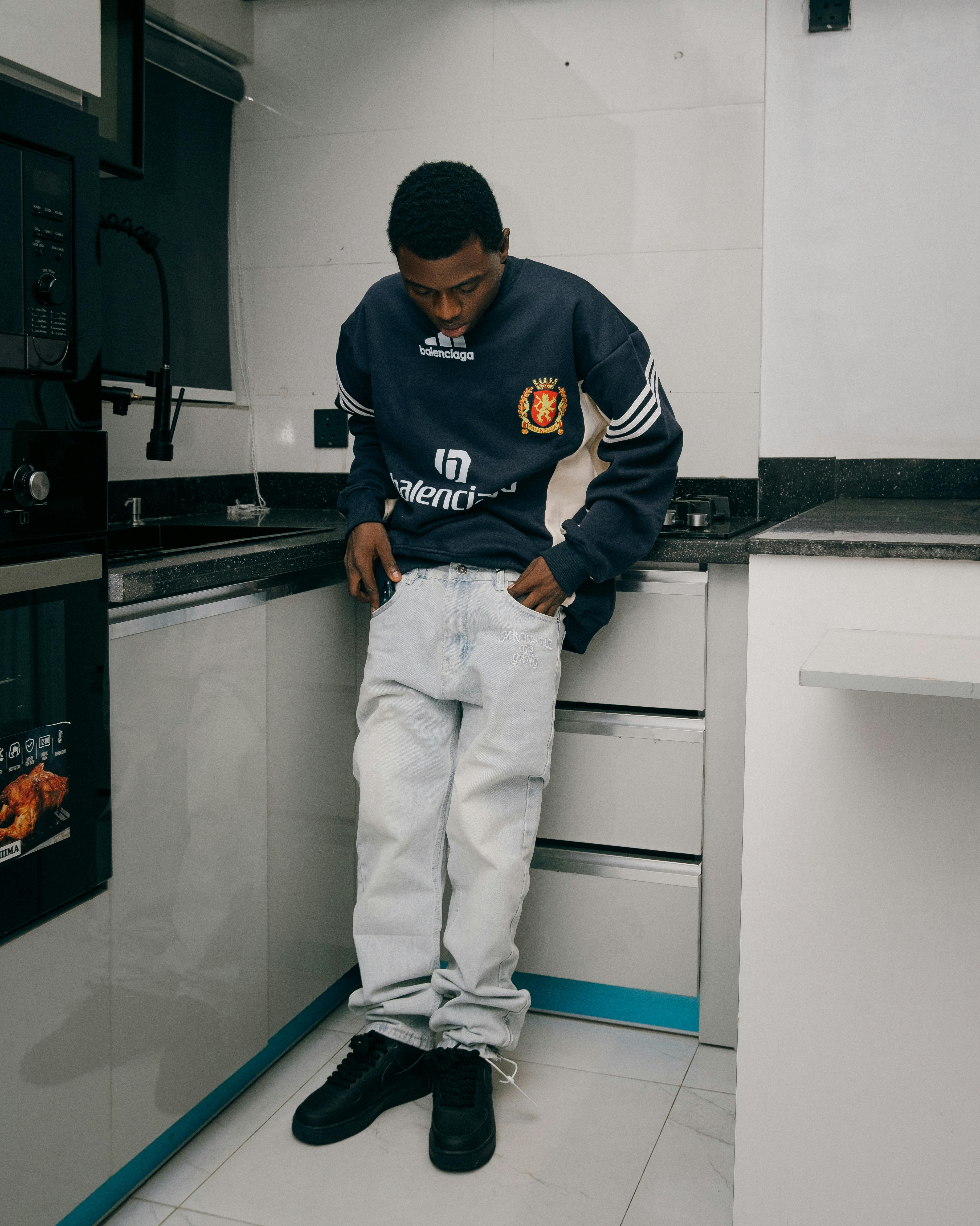 Male Model Leaning on Kitchen Drawers · Free Stock Photo