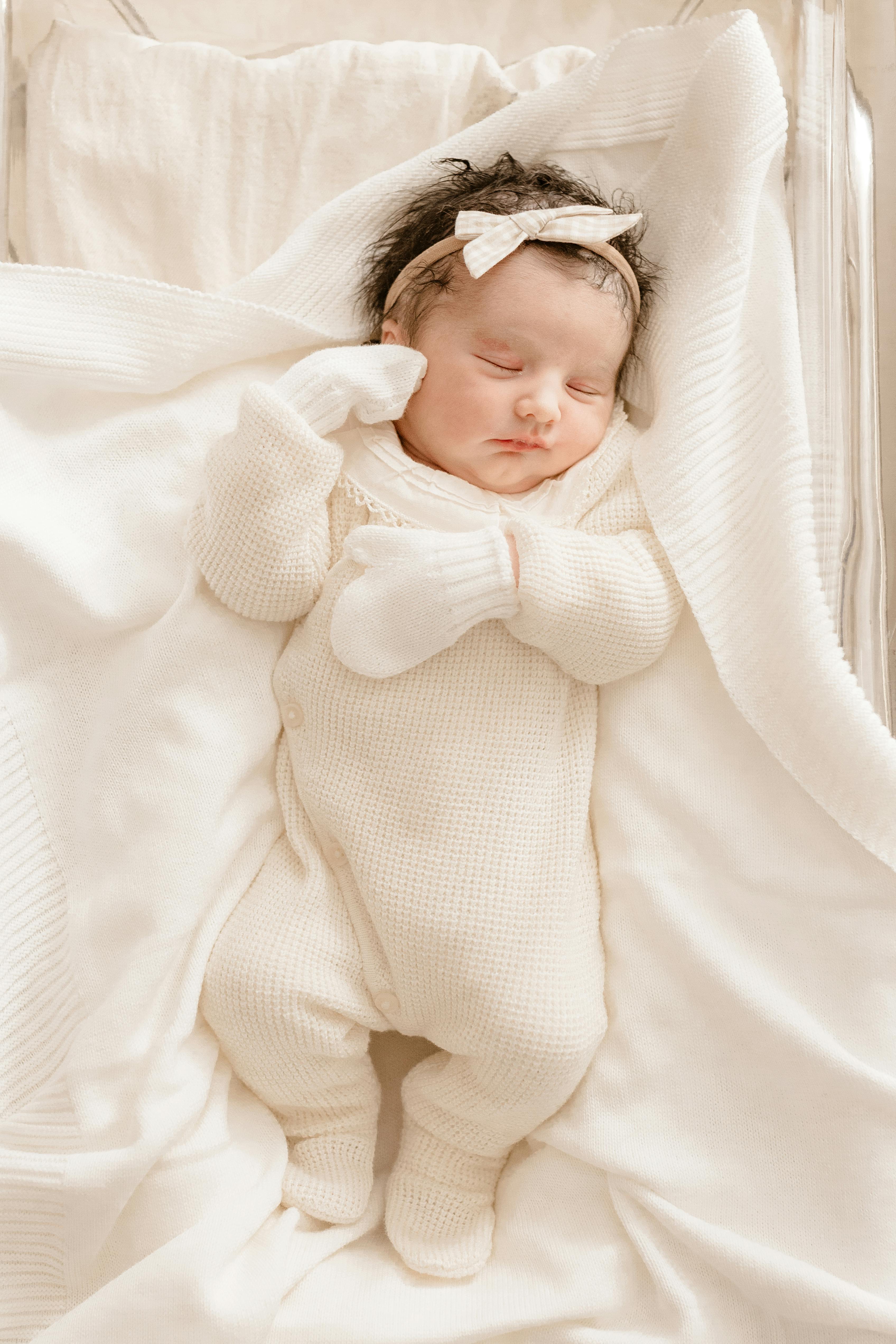 Baby Girl Sleeping in Gloves Free Stock Photo