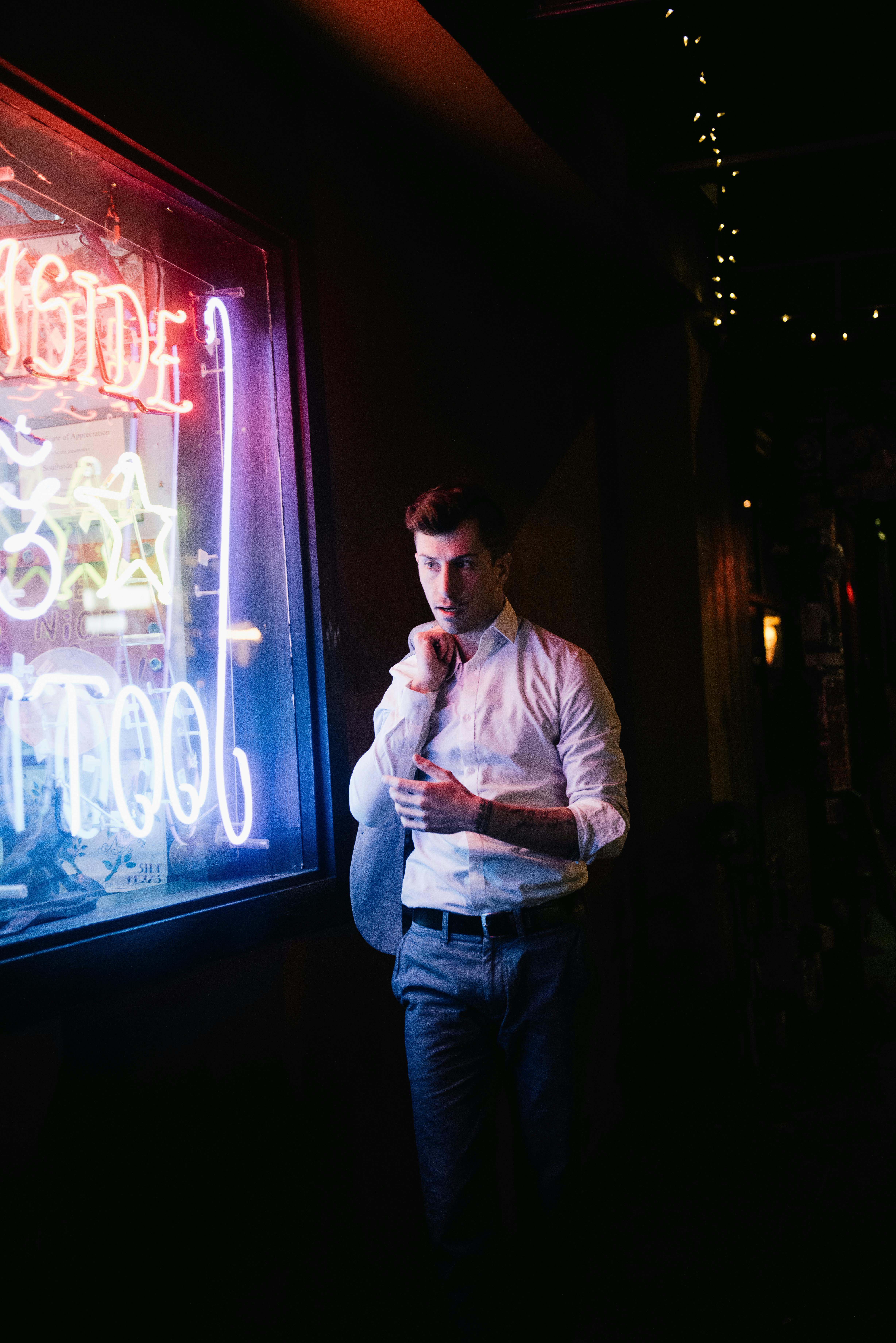 Man Holding Dslr Camera in Crouch Position · Free Stock Photo