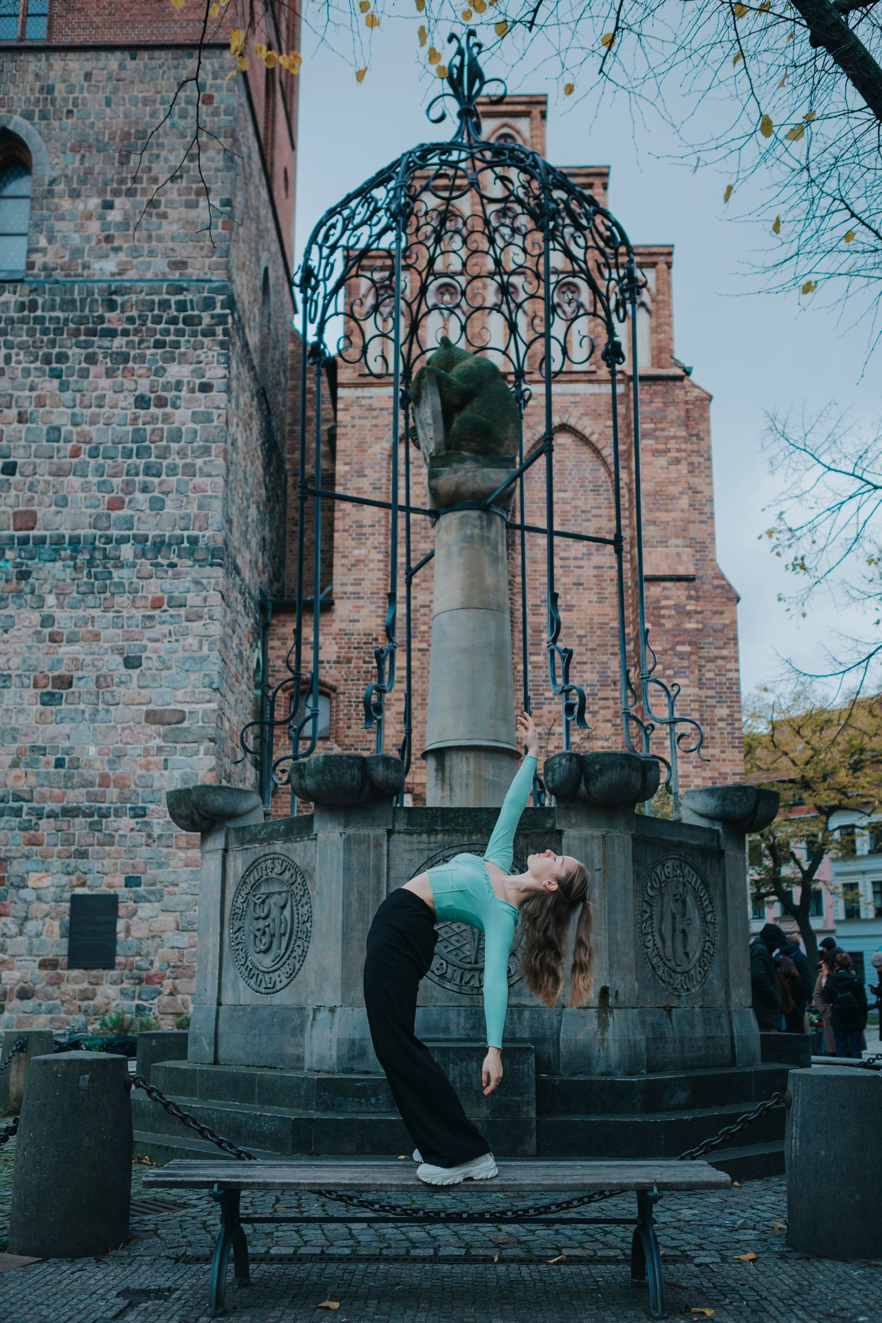 Young Woman Bending Backwards while Standing near a Statue in City ...