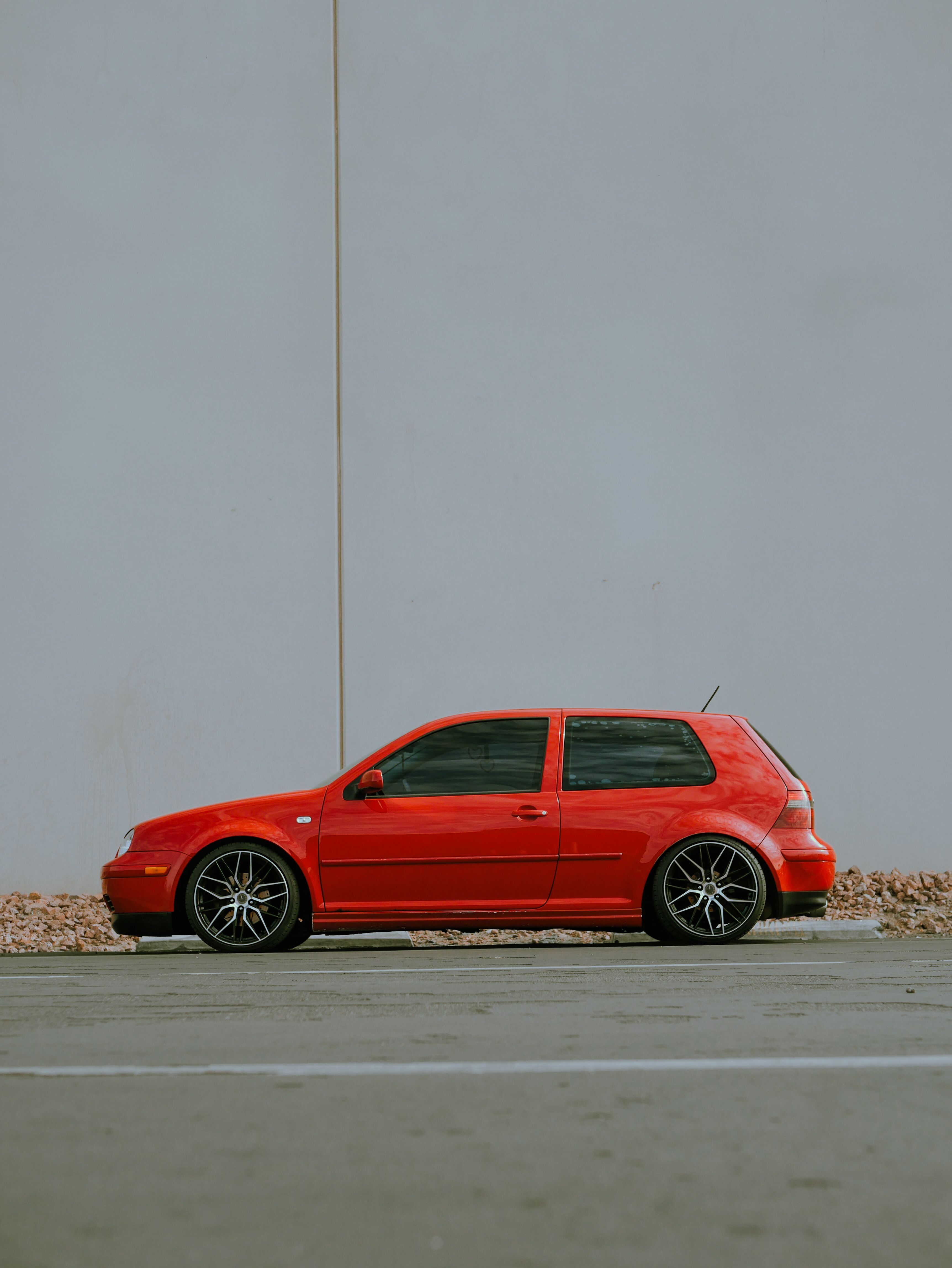 Red Volkswagen Golf IV Parked on Roadside under White Wall · Free Stock ...