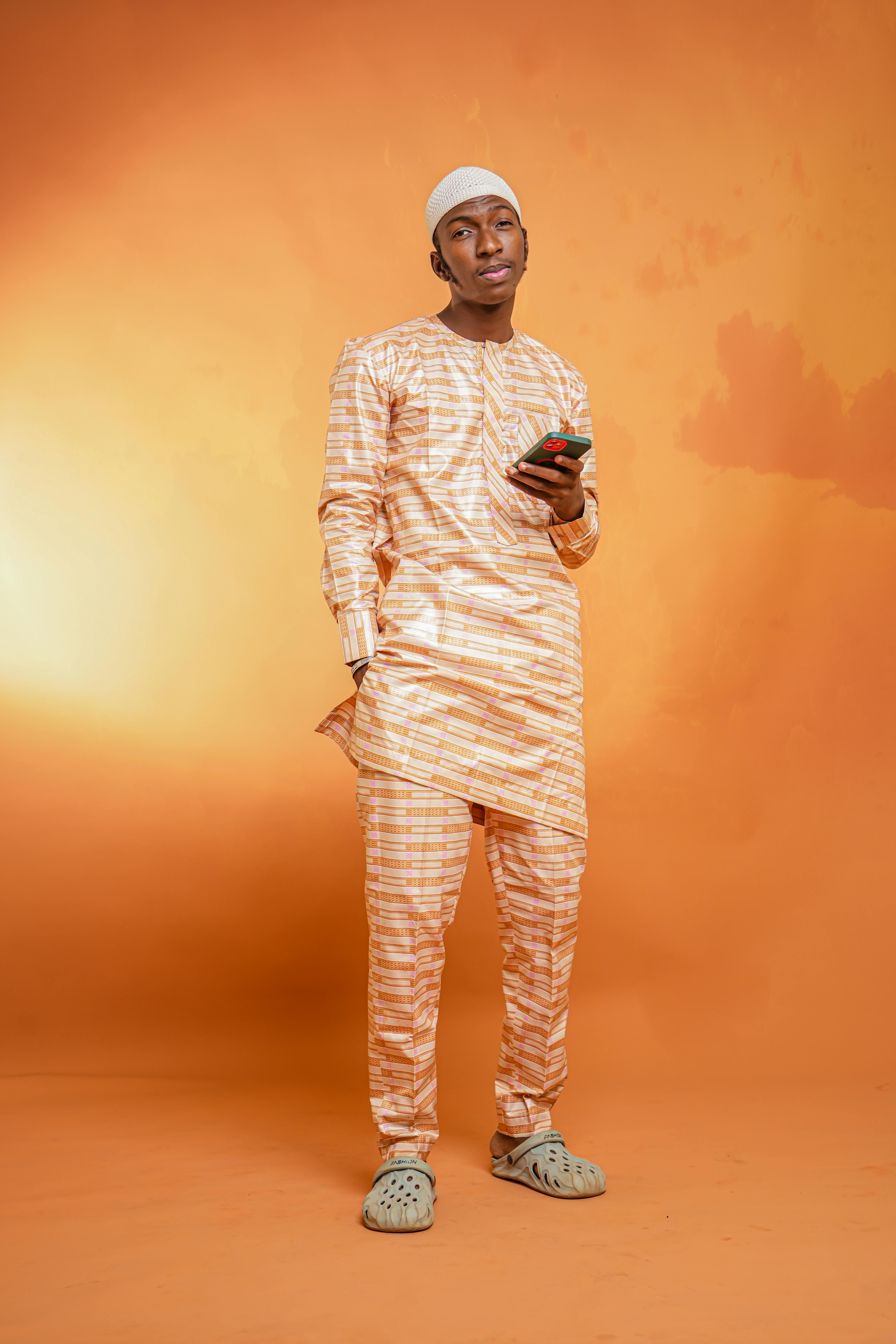 Male Model Standing in the Studio with a Smartphone in Hand · Free ...