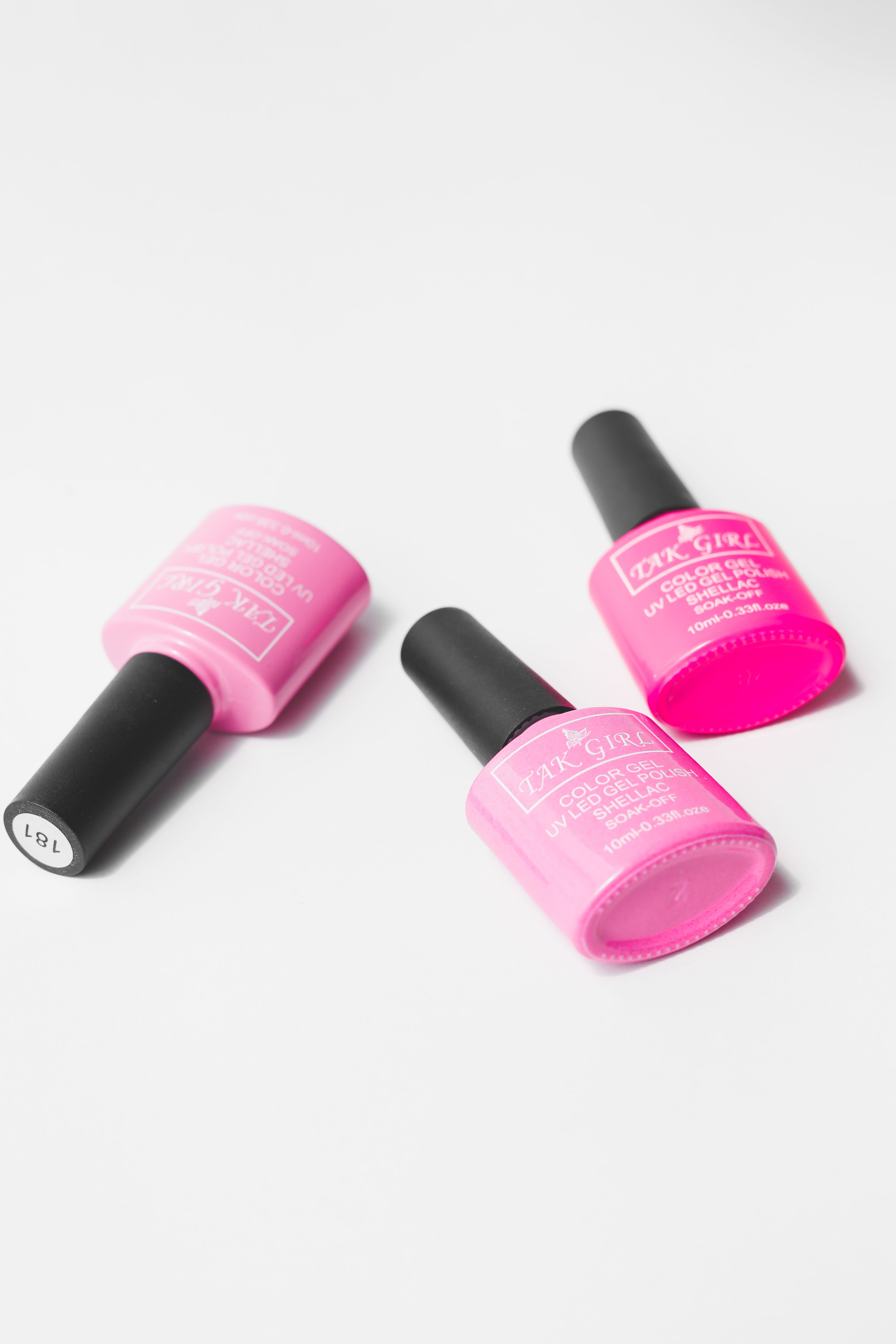 Photo of Two Red Lipsticks and Three Assorted-color Nail Polish Bottles ...