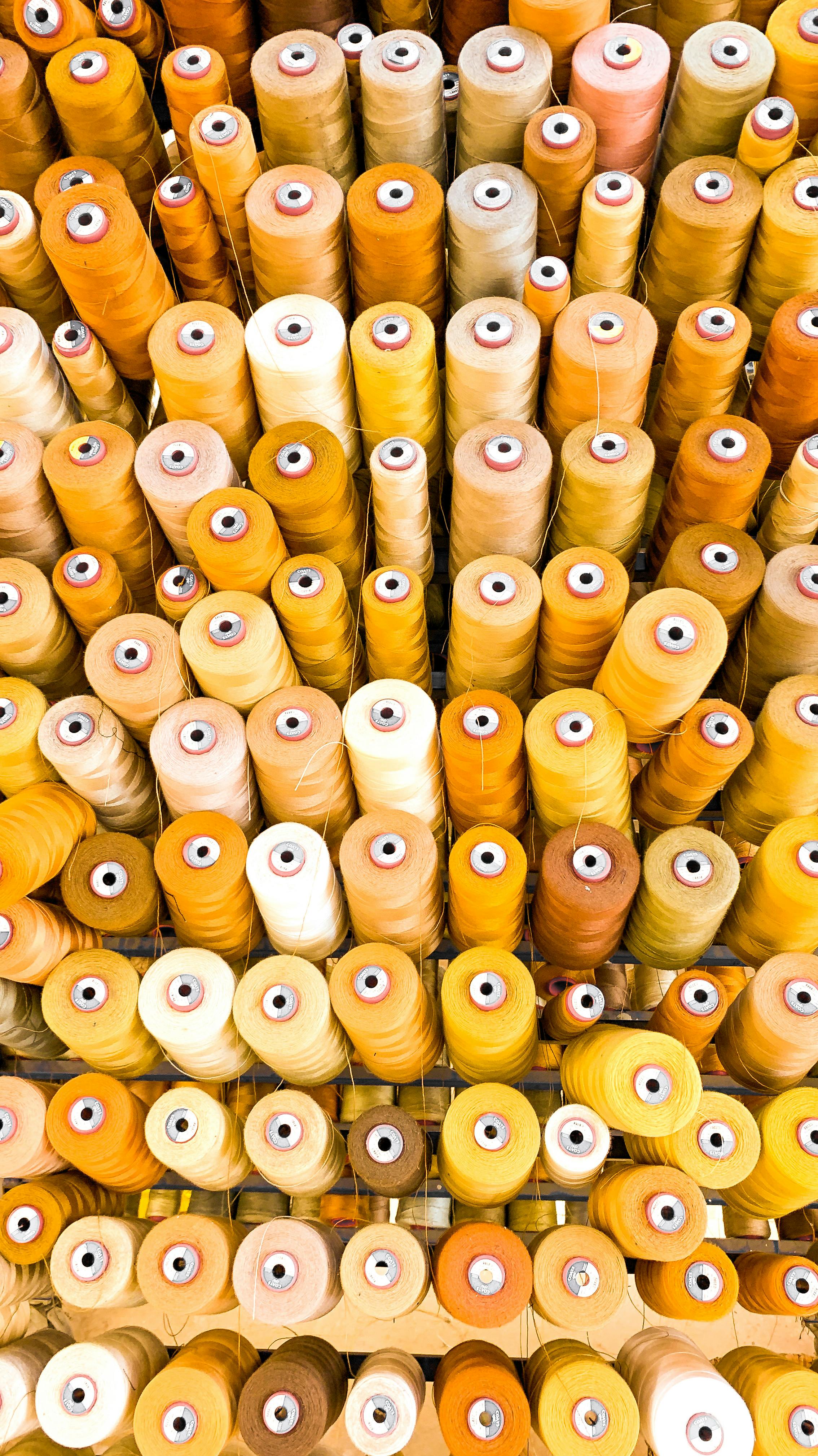 Yellow and Orange Spools of Sowing Thread · Free Stock Photo