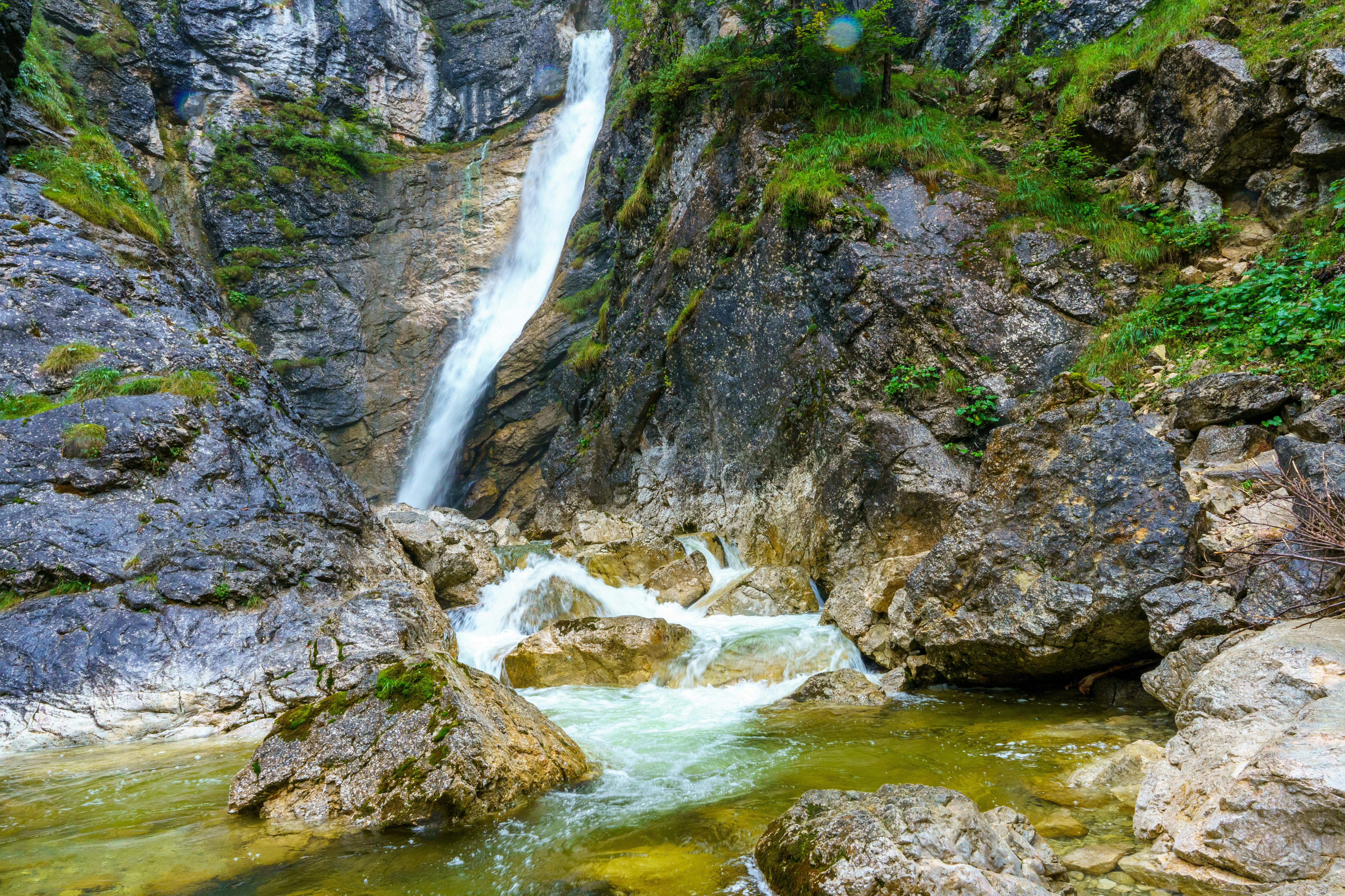 Narrow Waterfall Falling Down Rocks · Free Stock Photo
