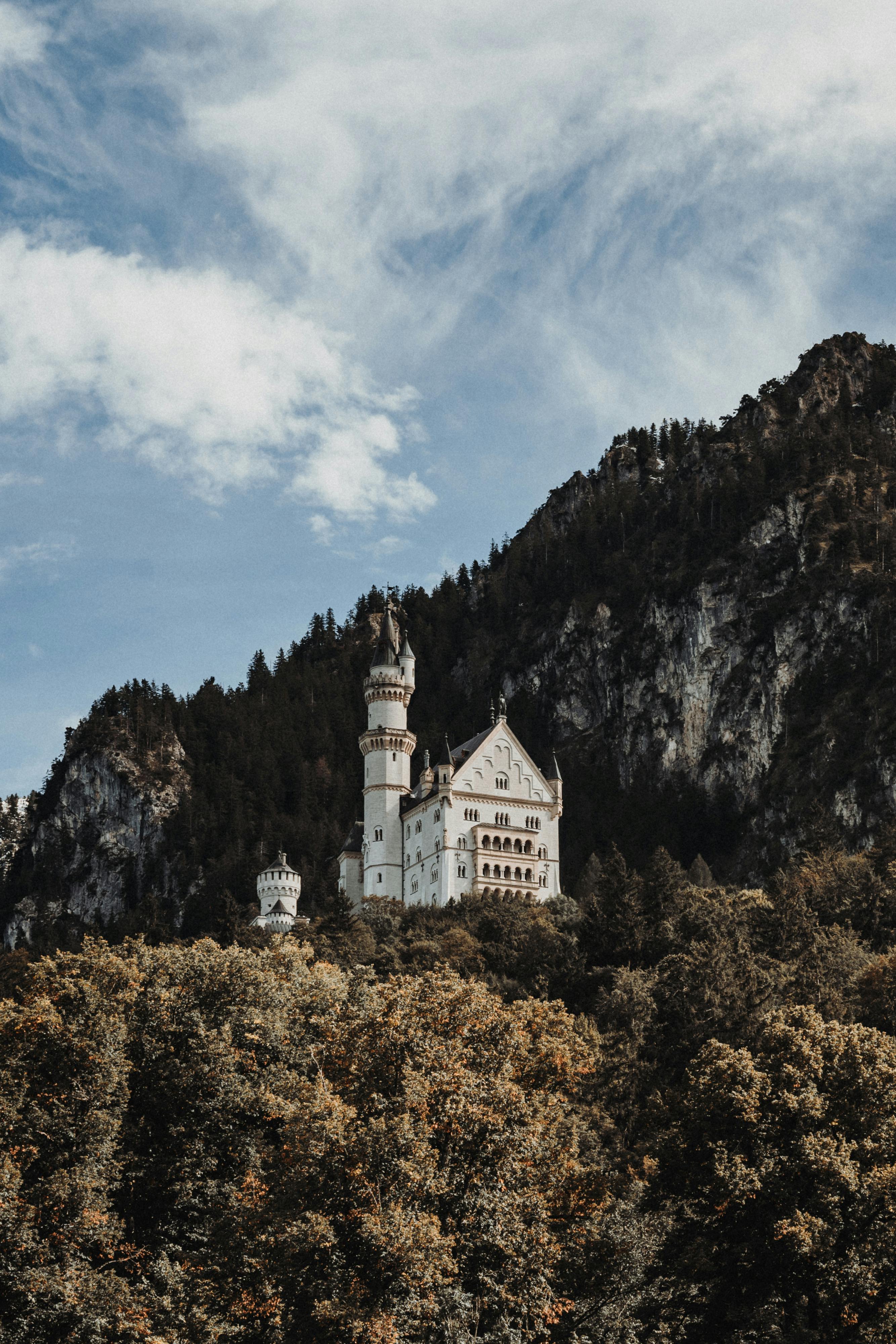 Neuschwanstein Castle on the Side of a Foggy Mountain · Free Stock Photo