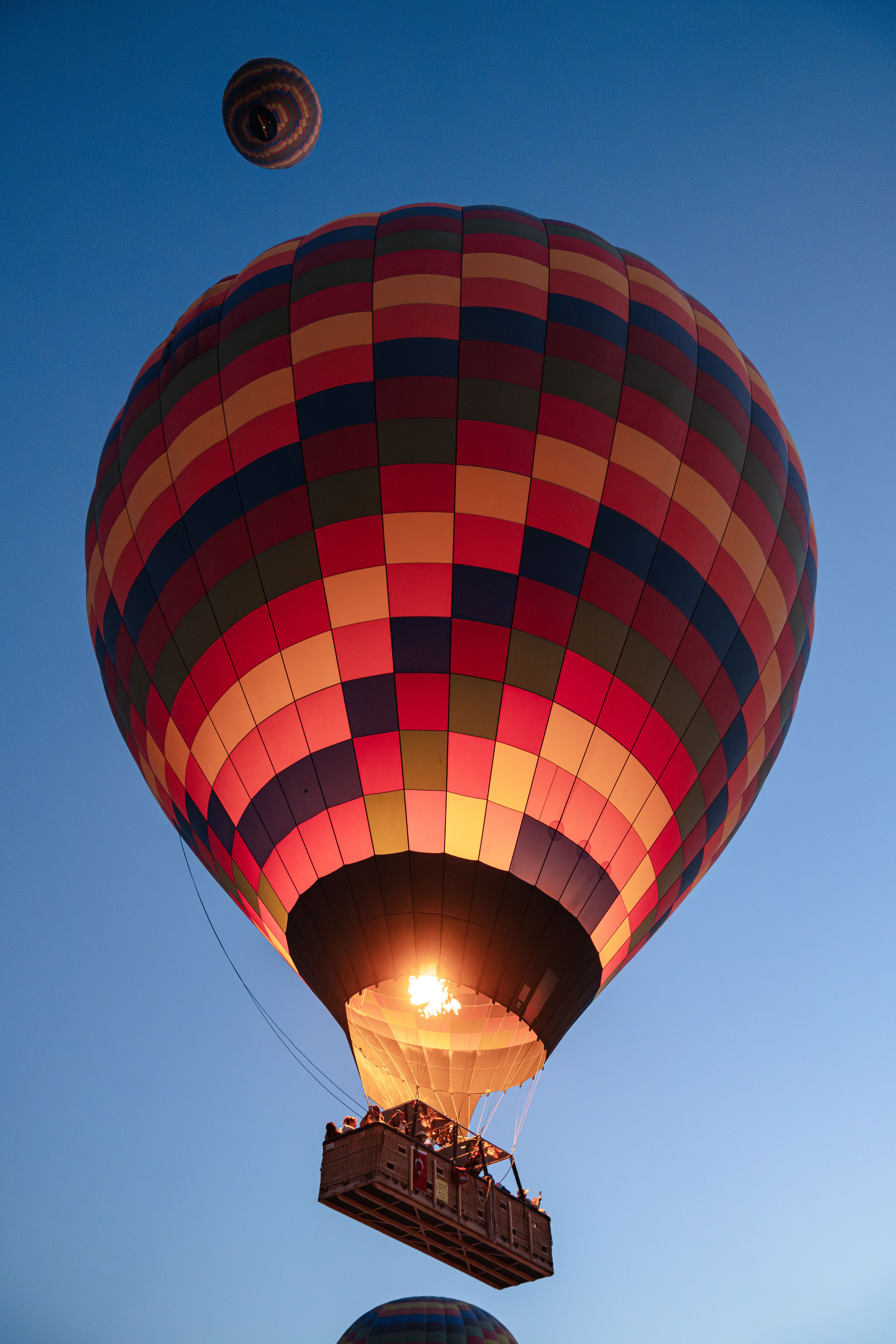 Low Angle Shot of a Flying Colorful Hot Air Balloon · Free Stock Photo