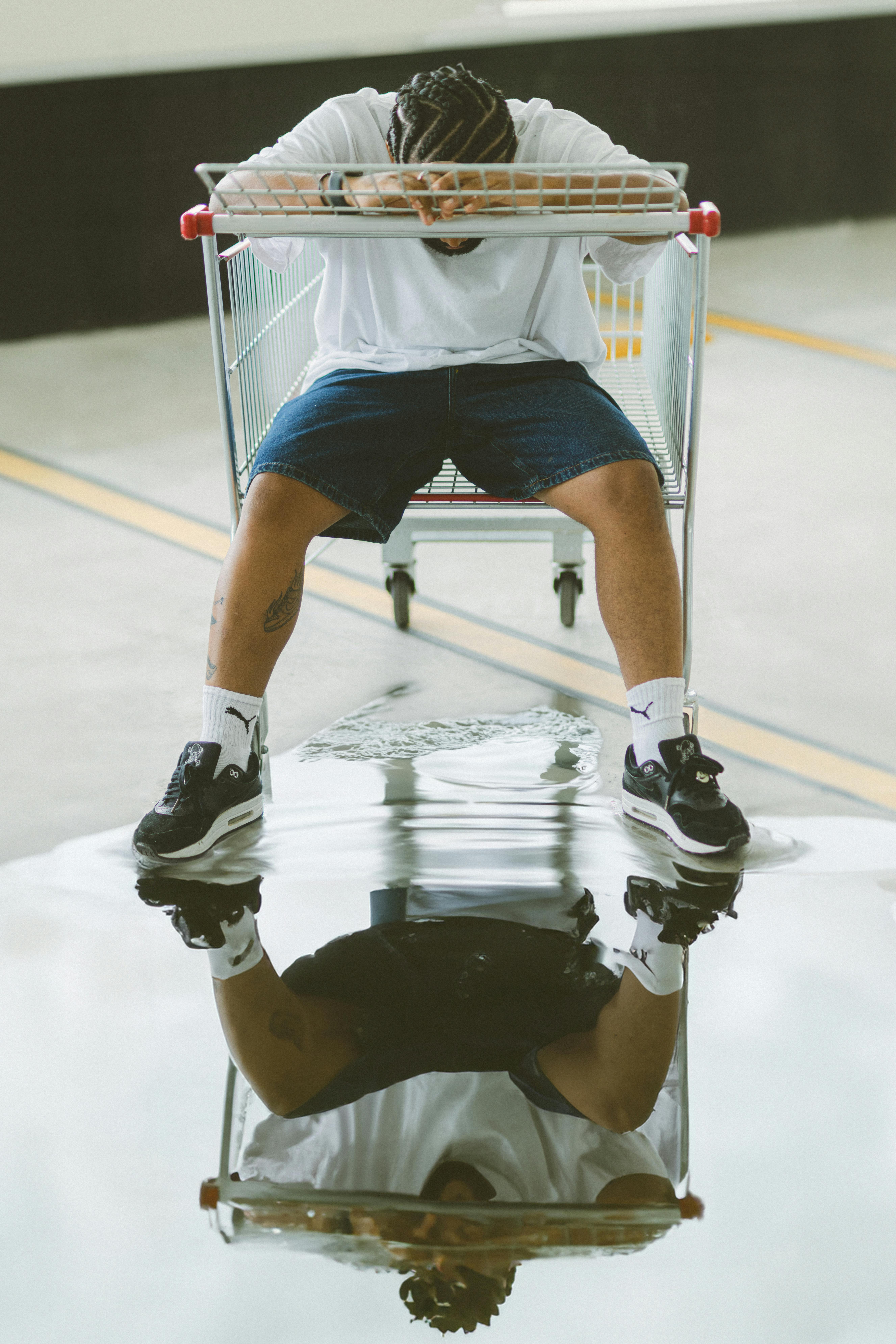 Man in Shorts Reflecting in Puddle · Free Stock Photo