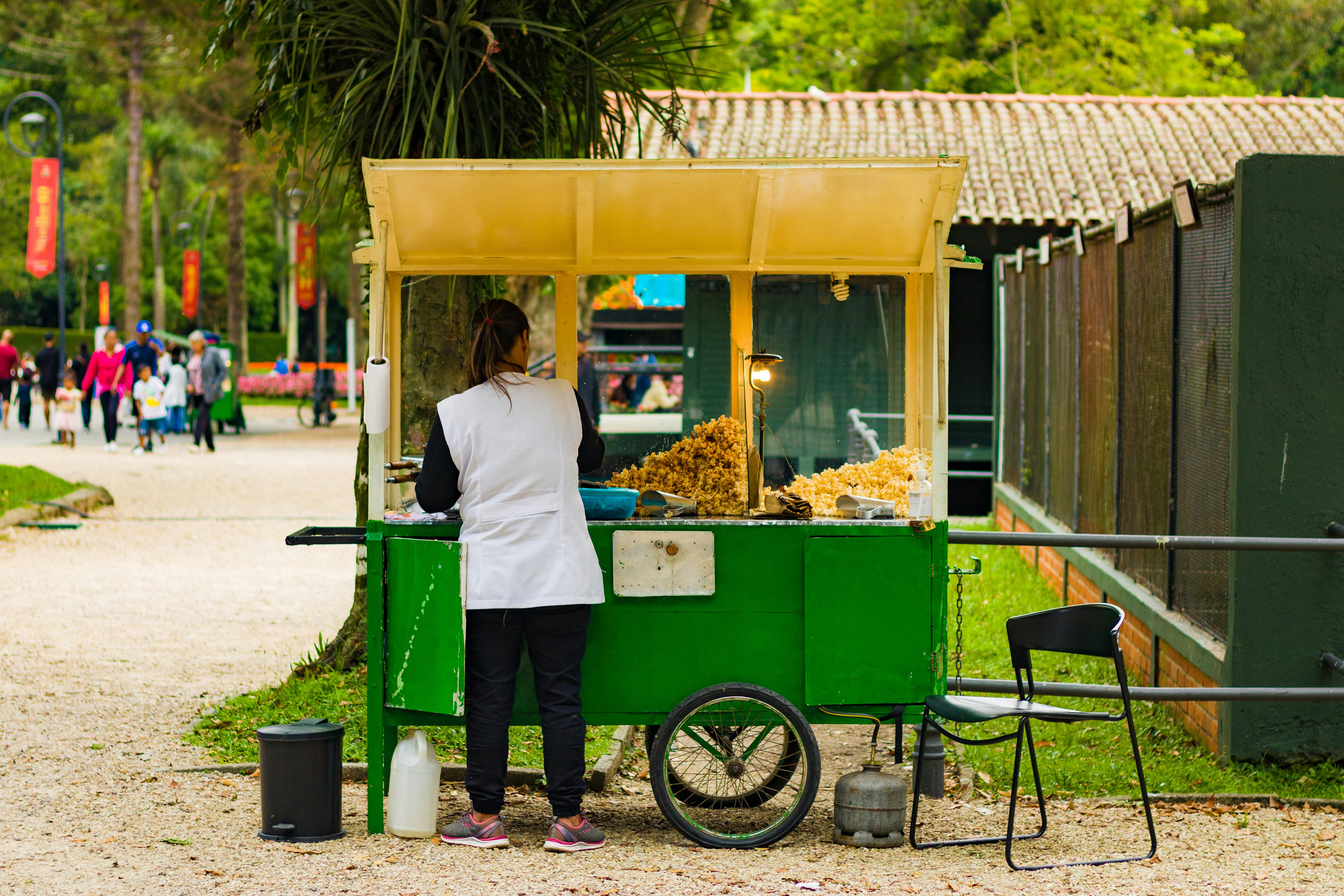 Woman Selling Food in a Cart · Free Stock Photo