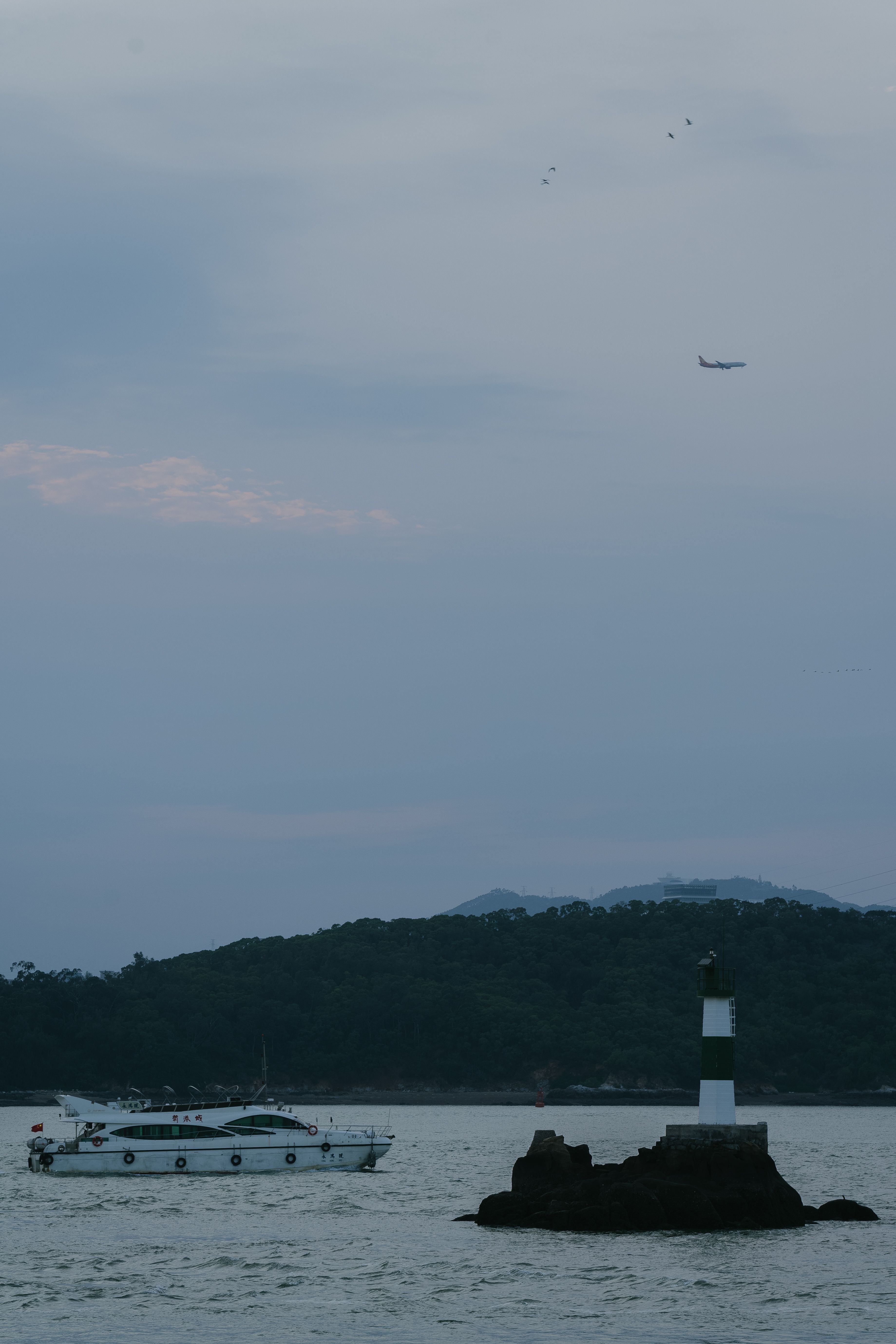 Luxurious Yacht Passing Beacon in Bay · Free Stock Photo
