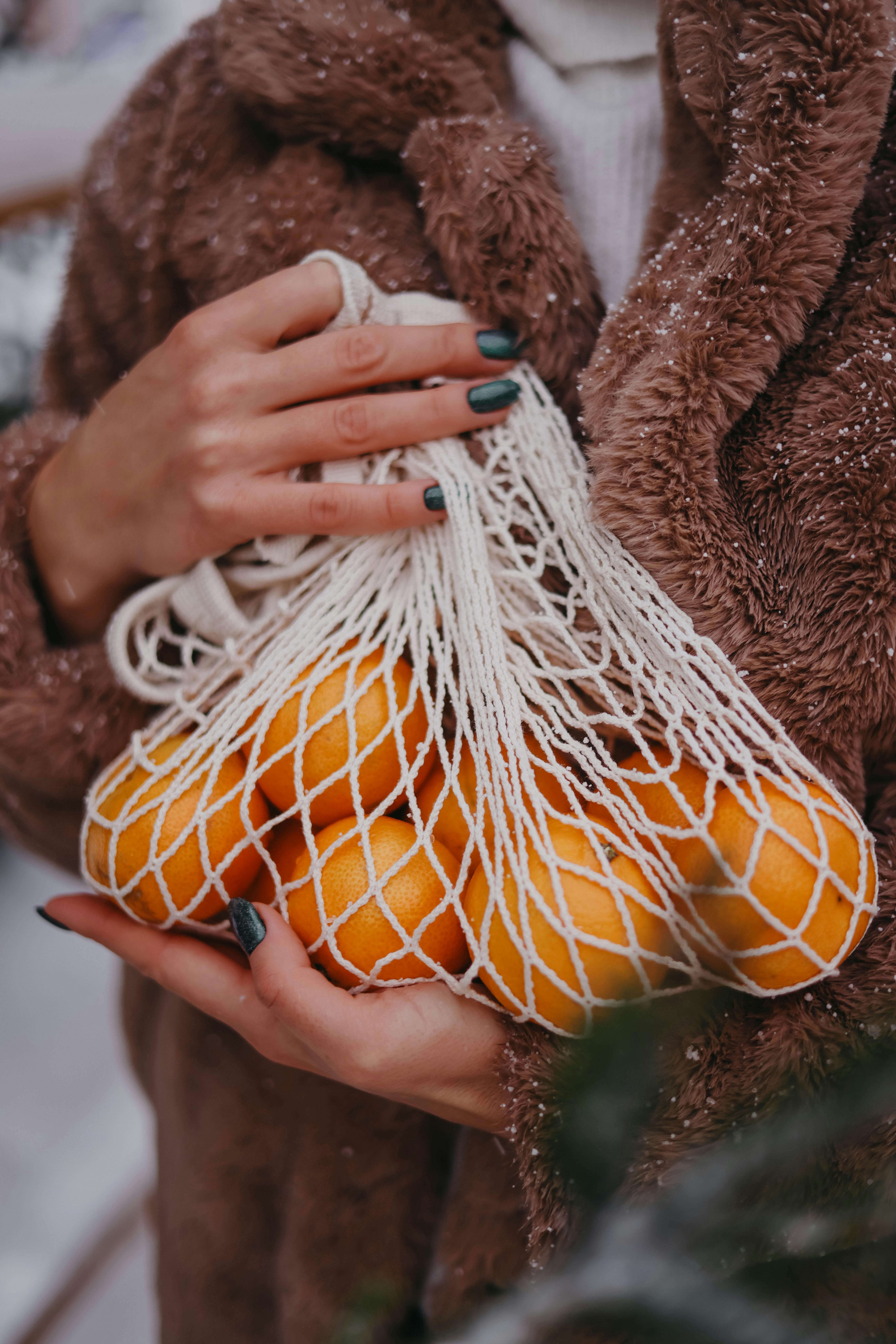 Woman Hands Holding Bag of Tangerines · Free Stock Photo