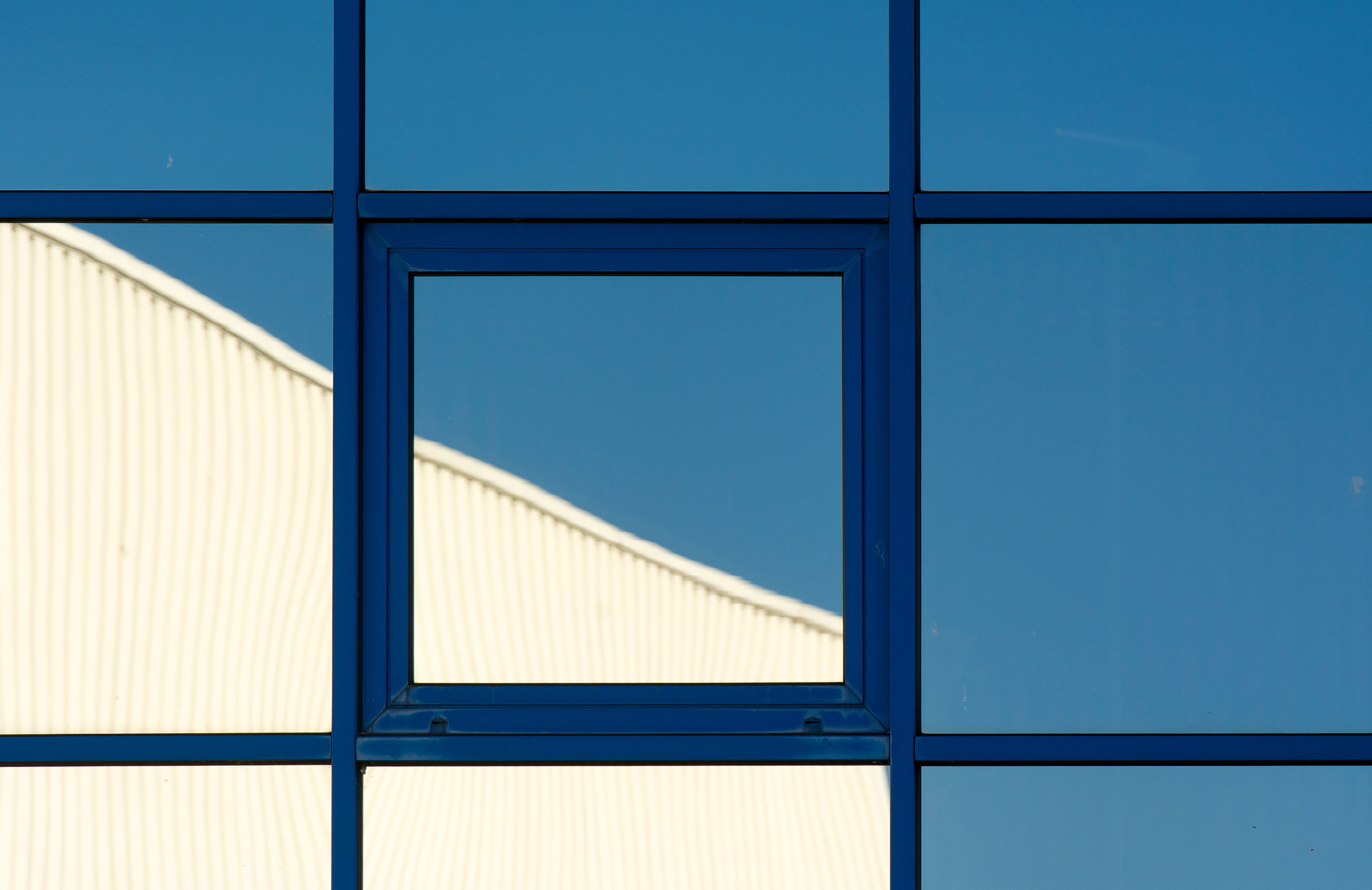 Sunlight over Glass Building Wall · Free Stock Photo