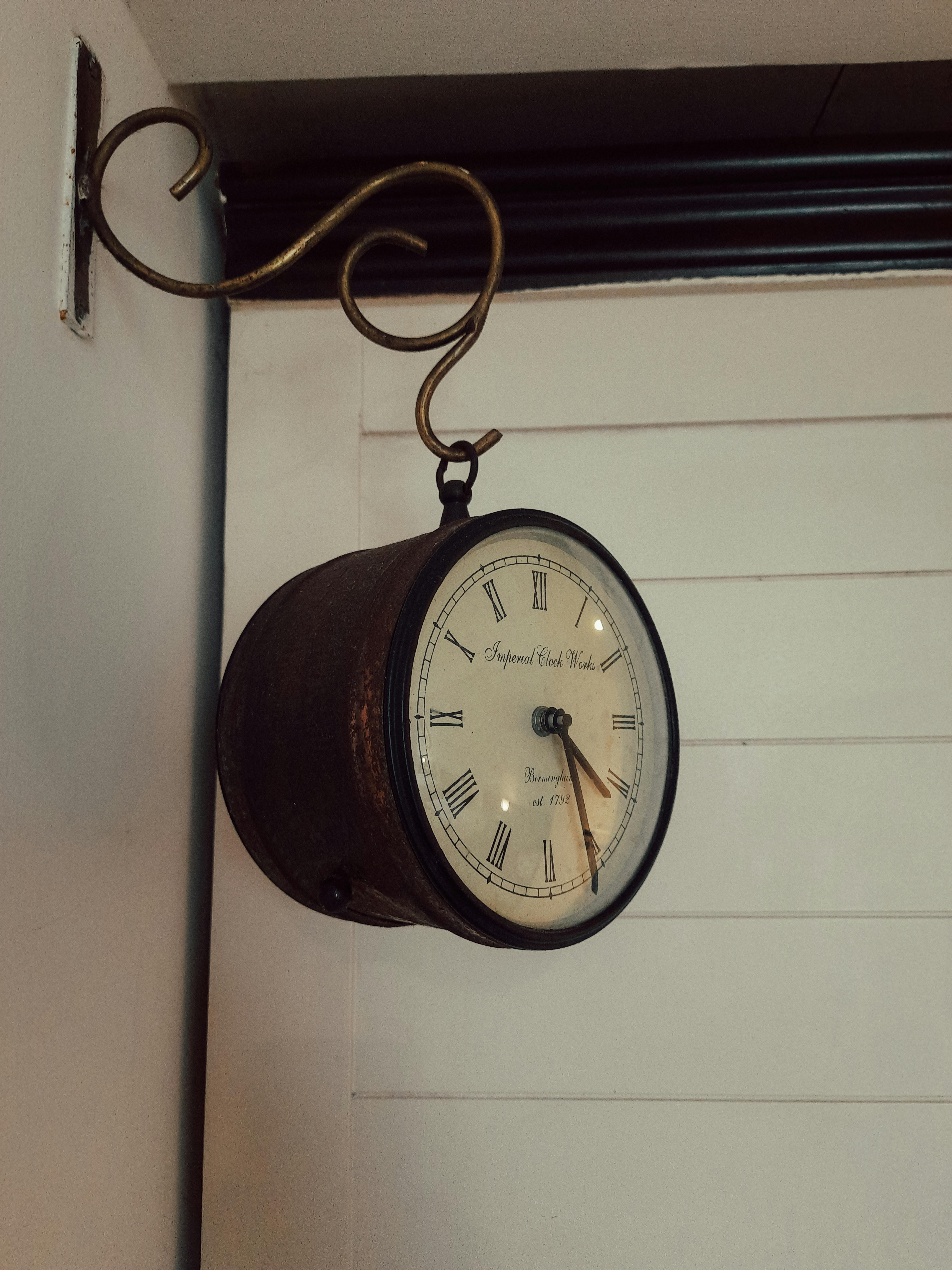 Clock Hanging in Corner on Wall · Free Stock Photo