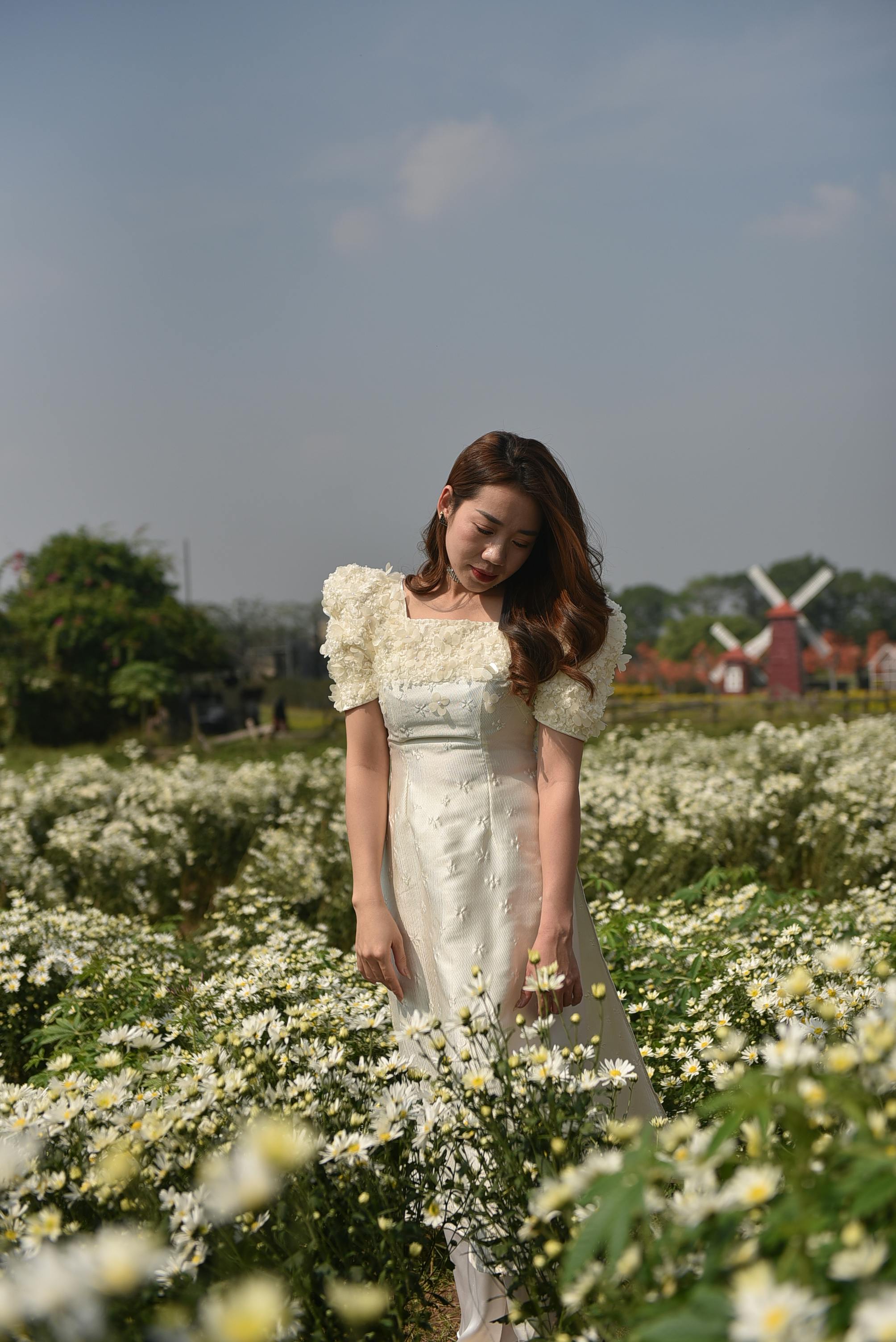 Woman in Puff Dress Standing on a Flower Field while Looking at the ...