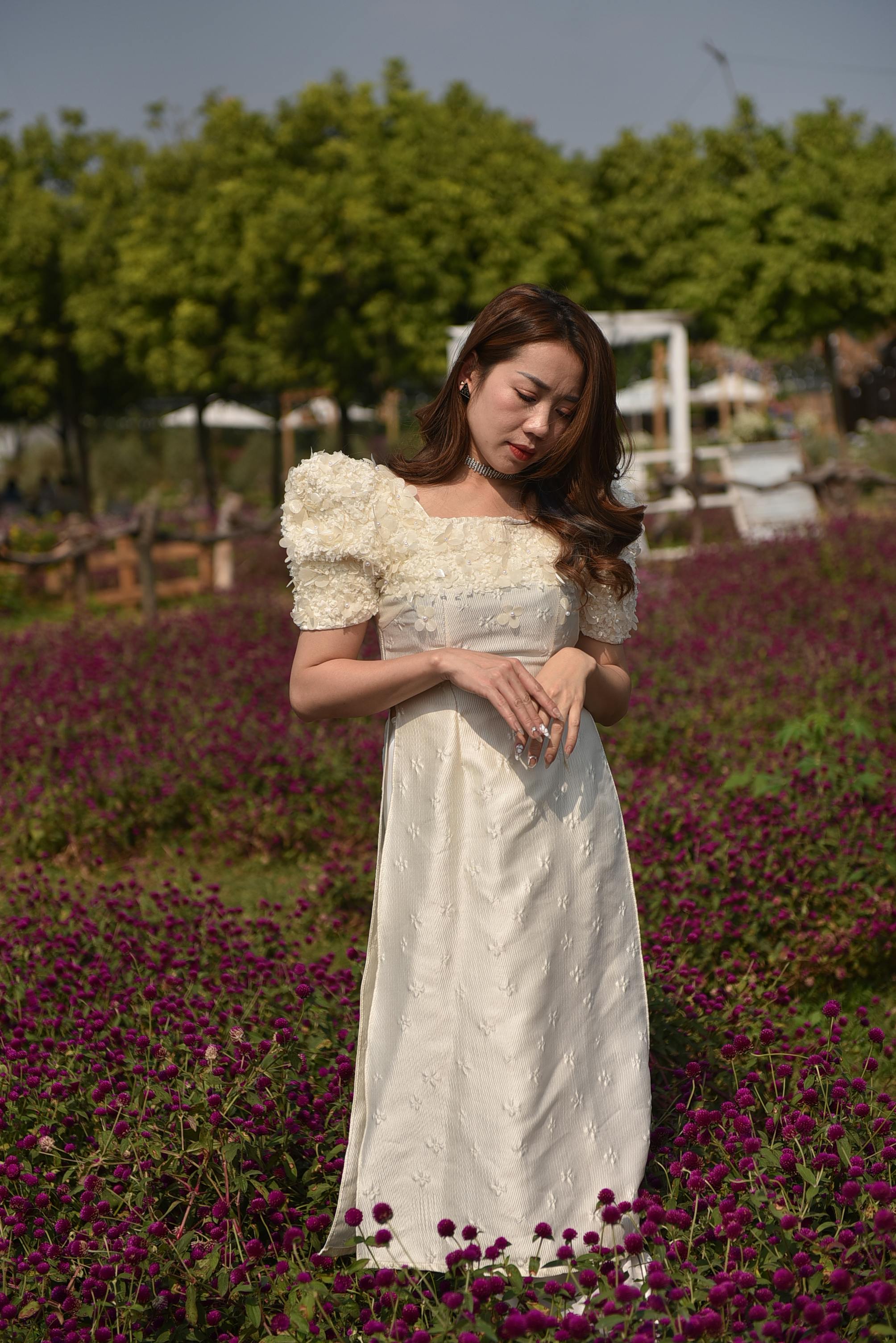 Woman in Puff Dress Standing on a Flower Field while Looking at the ...