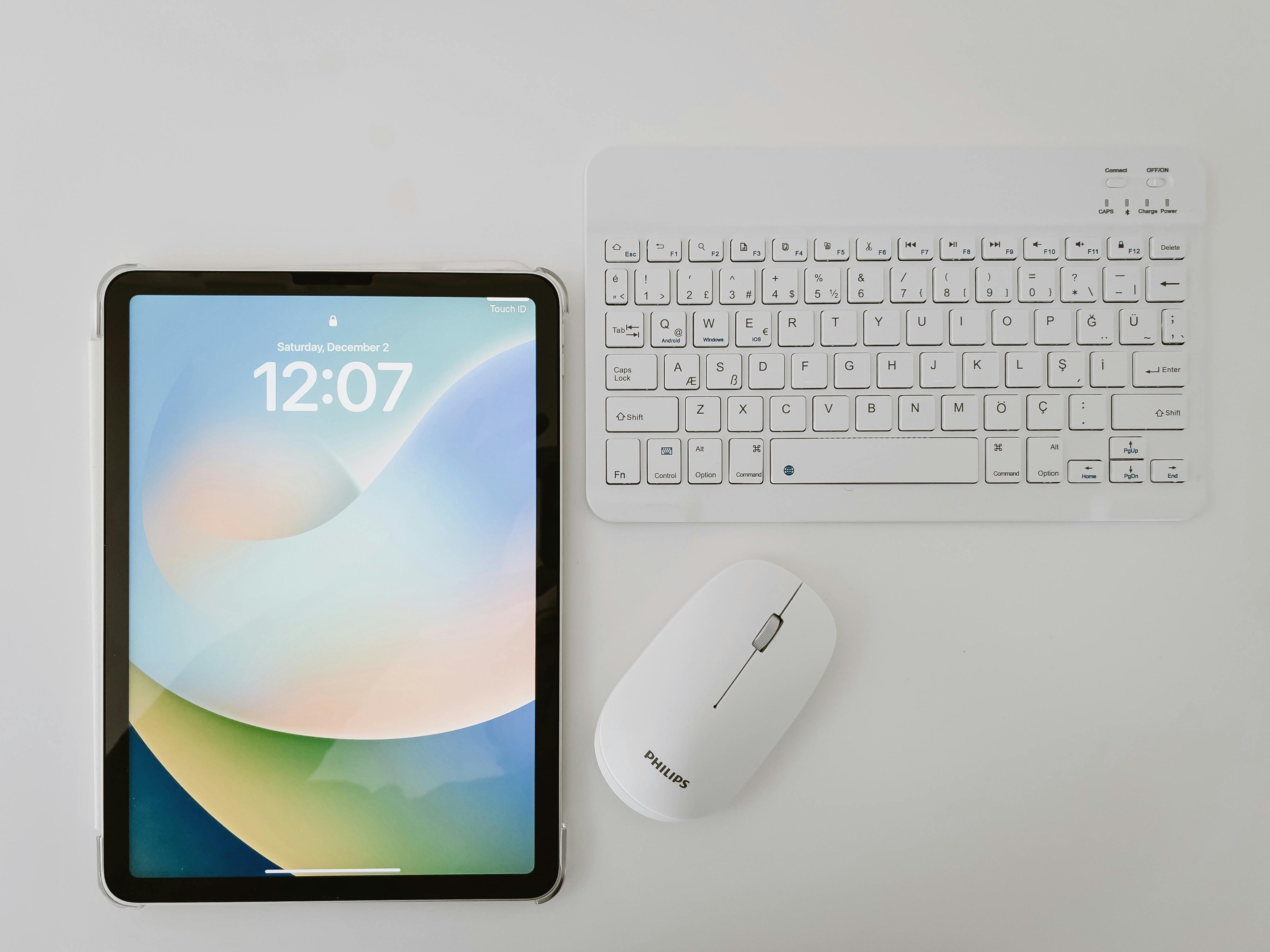 Philips Wireless Mouse and Keyboard Next to the Tablet · Free Stock Photo