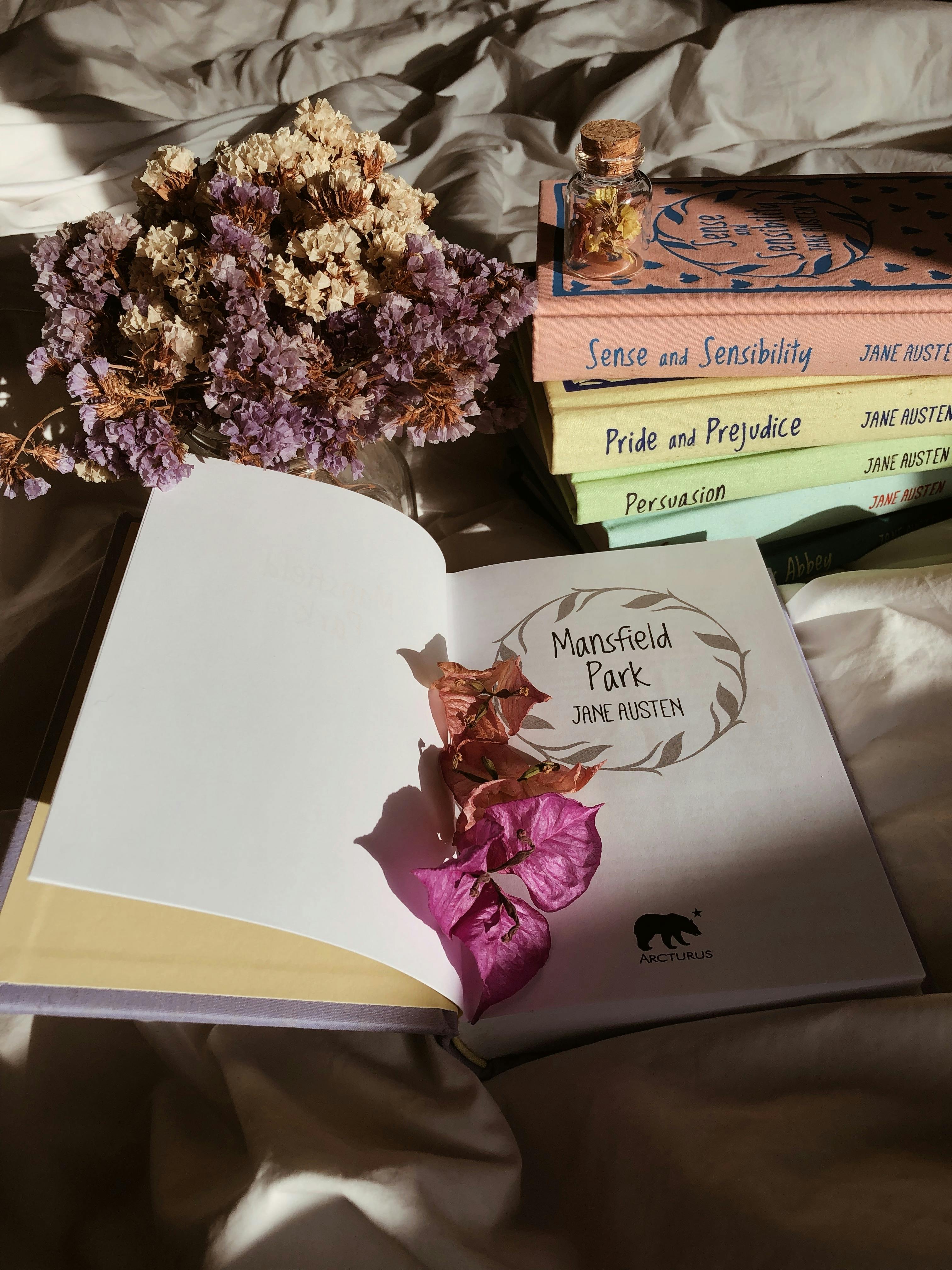 Flowers on Book on Bed · Free Stock Photo