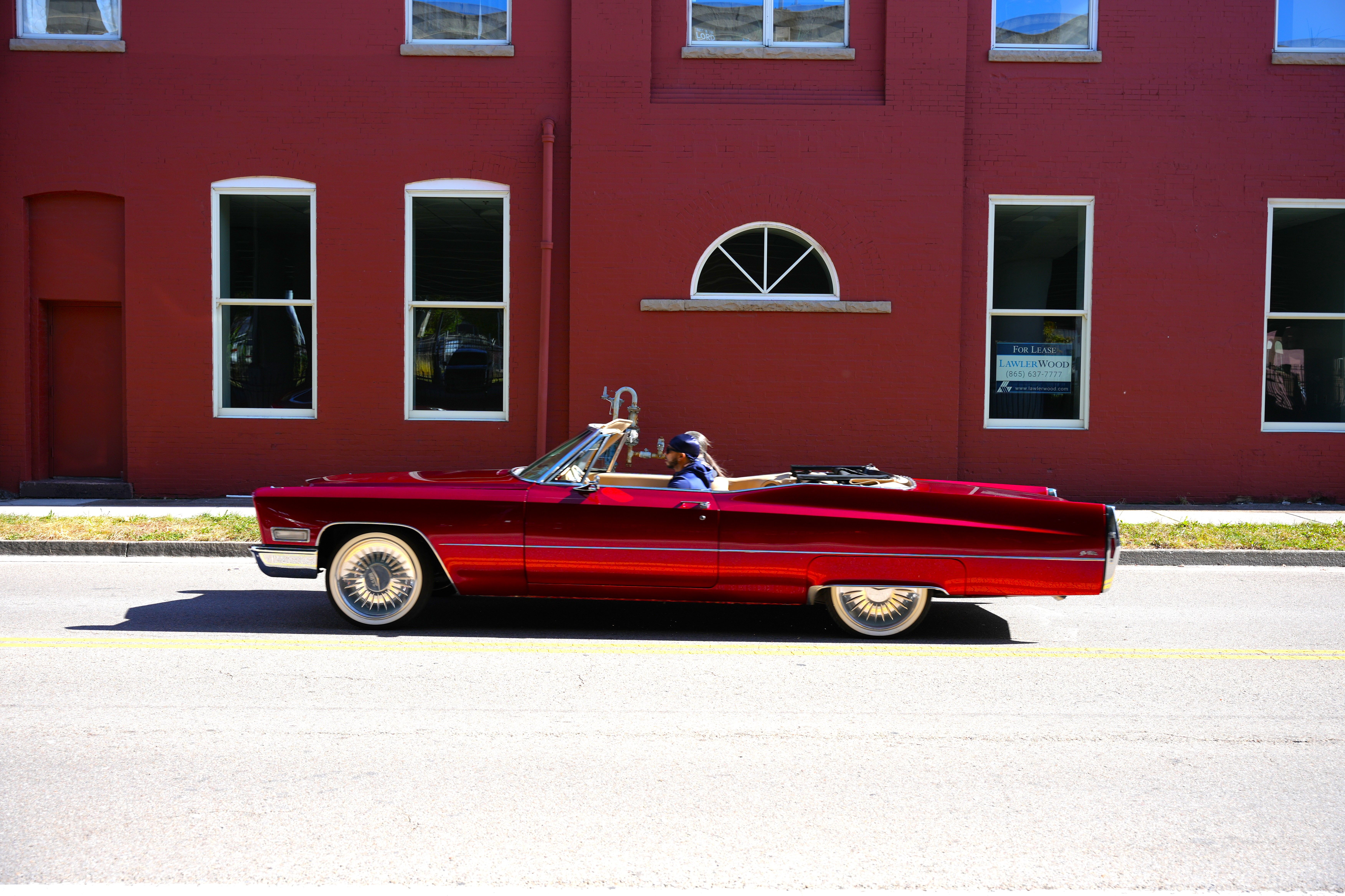 Man Driving Red Luxury Cadillac · Free Stock Photo