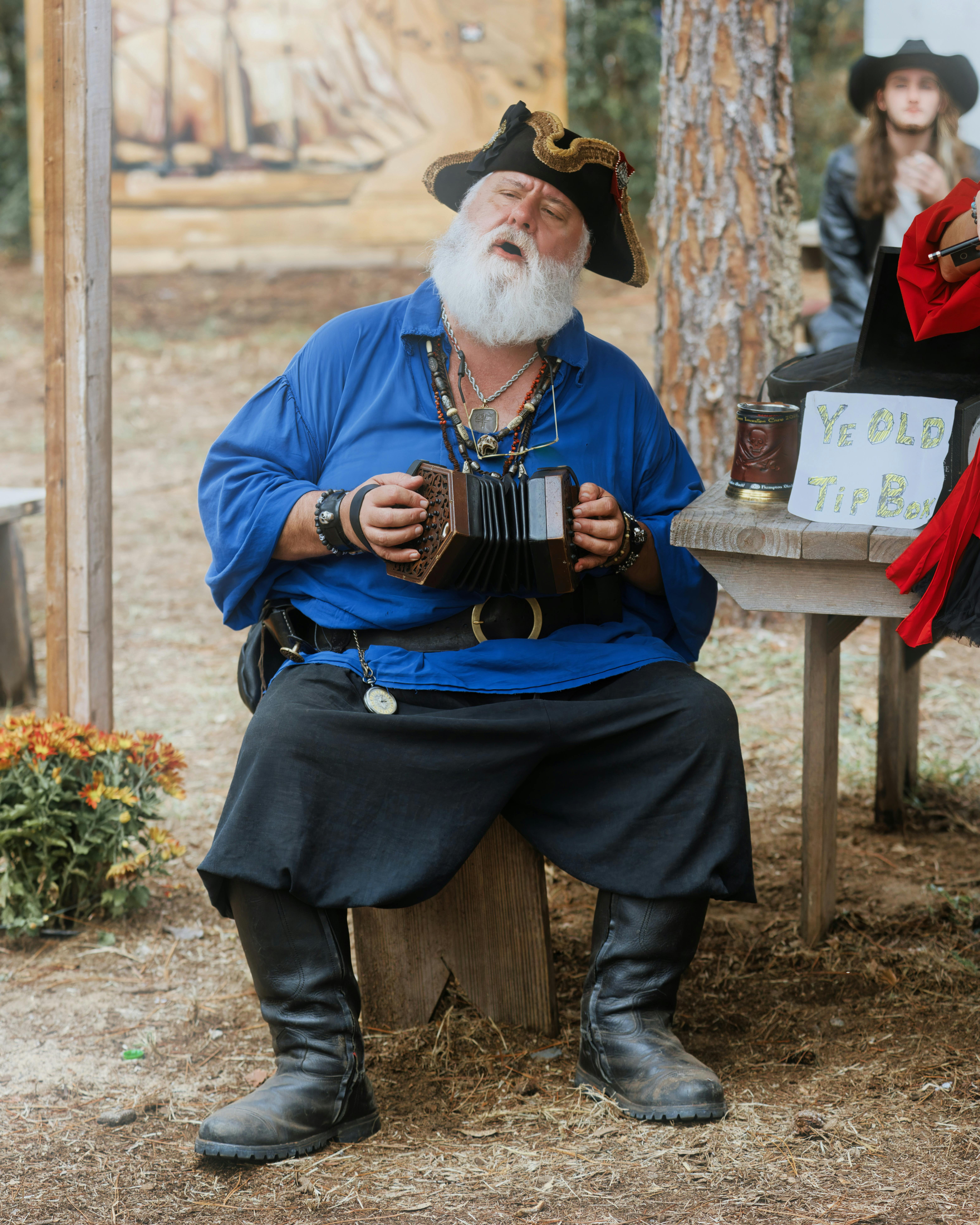 Man Dressed in Pirate Costume Playing Concertina · Free Stock Photo