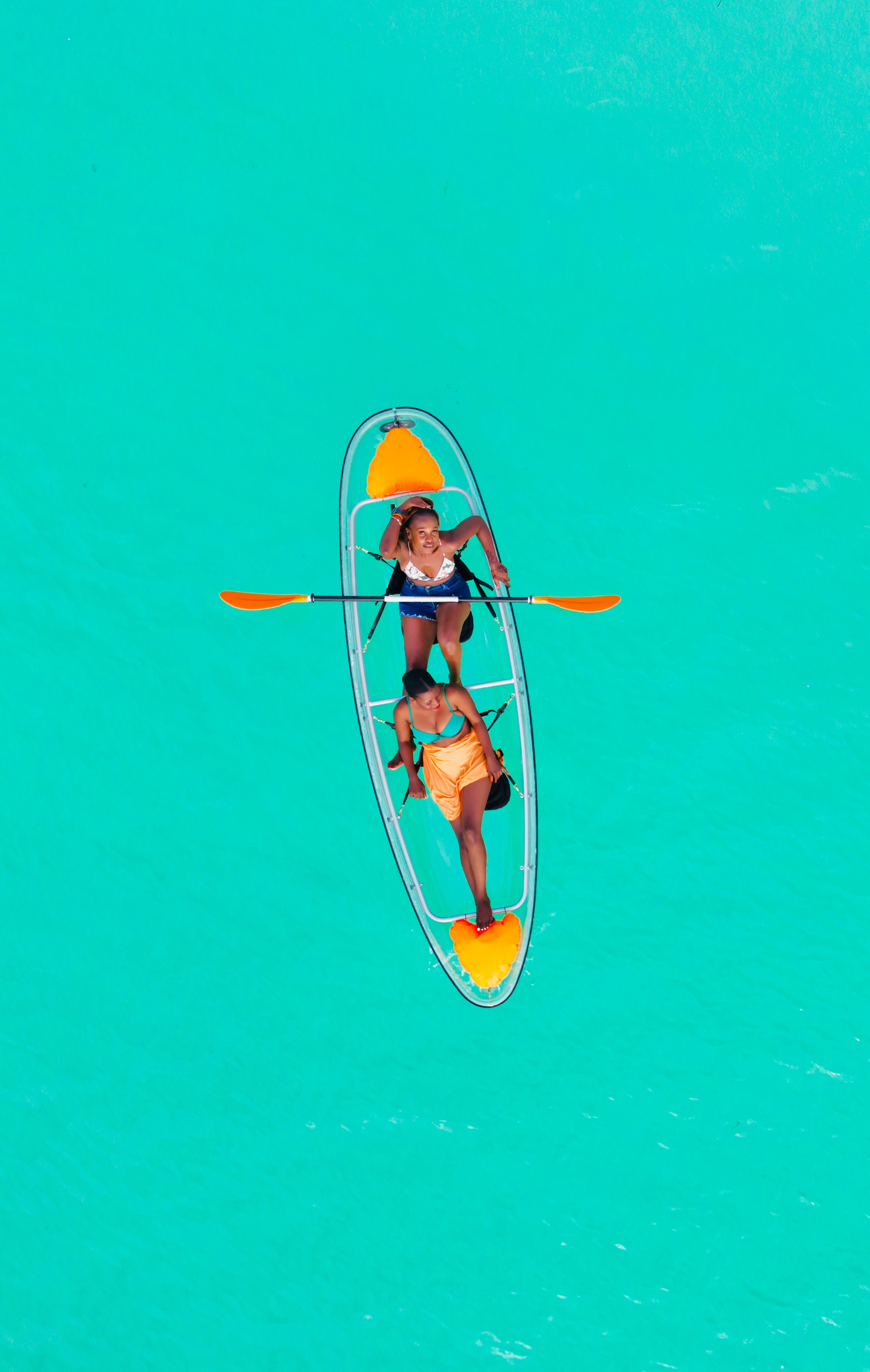 Women Canoeing on Turquoise Water · Free Stock Photo