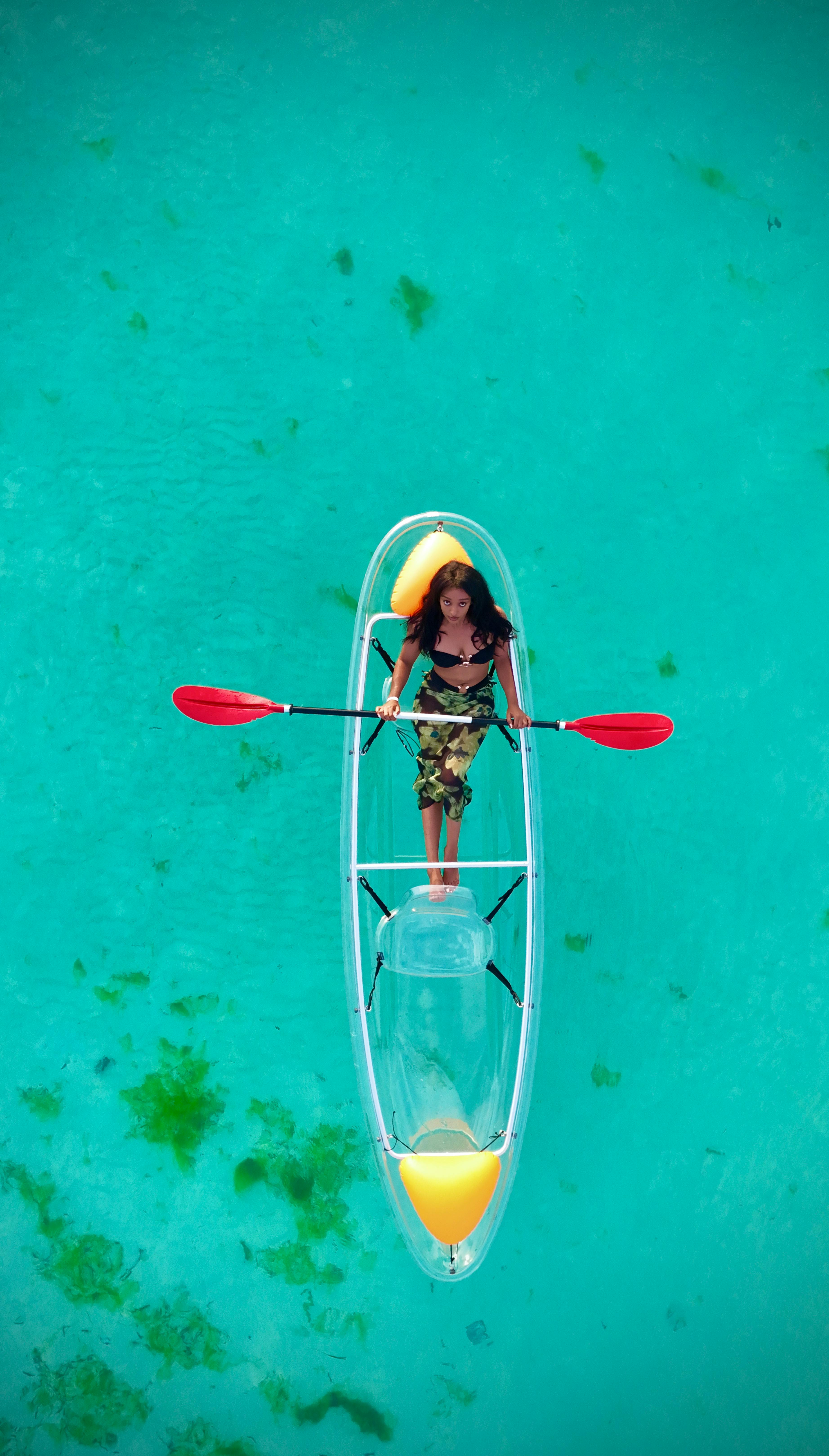 Woman Sitting in Canoe on Turquoise Water · Free Stock Photo