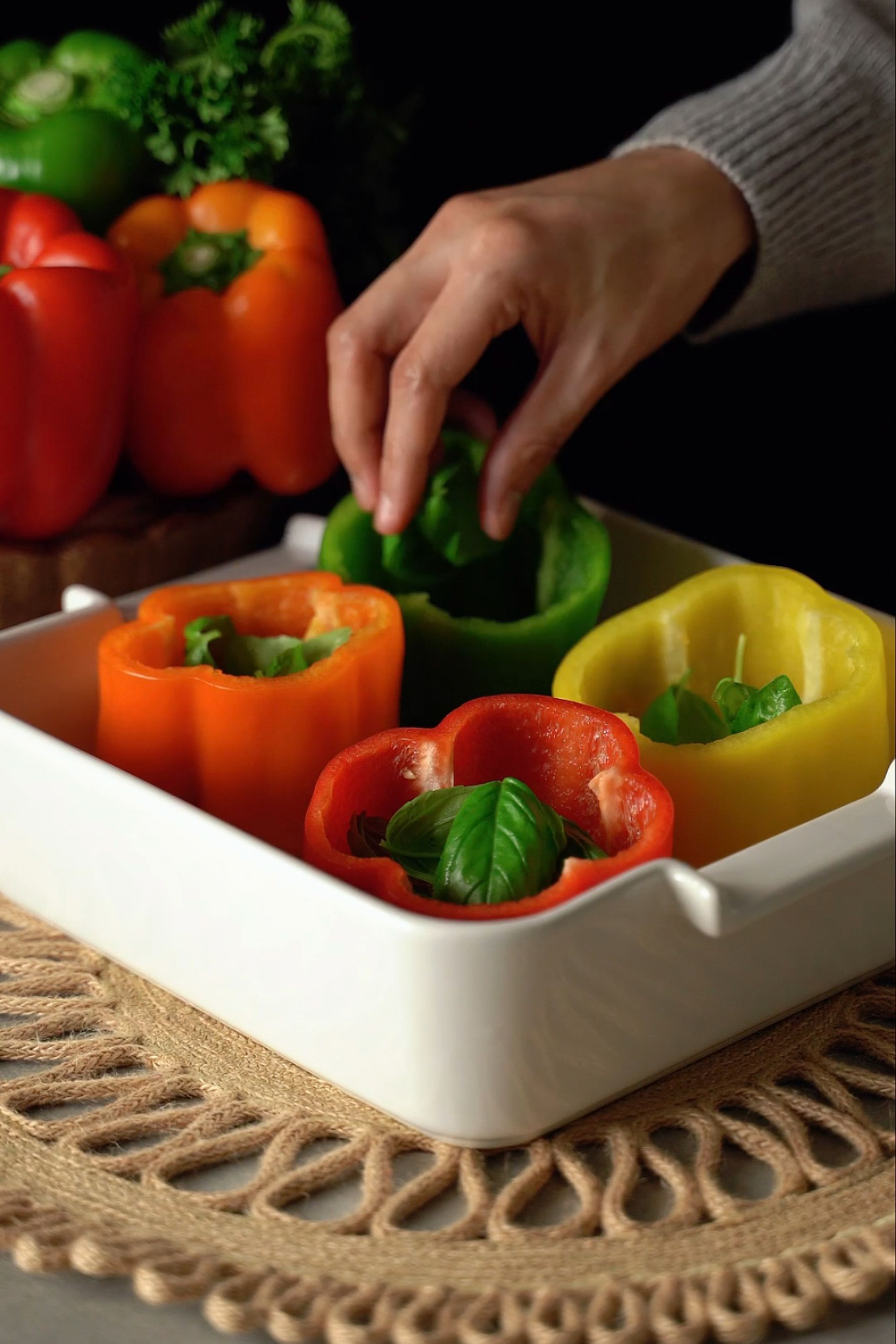 Close-up of a Person Putting Basil Leaves inside the Peppers on a Tray ...