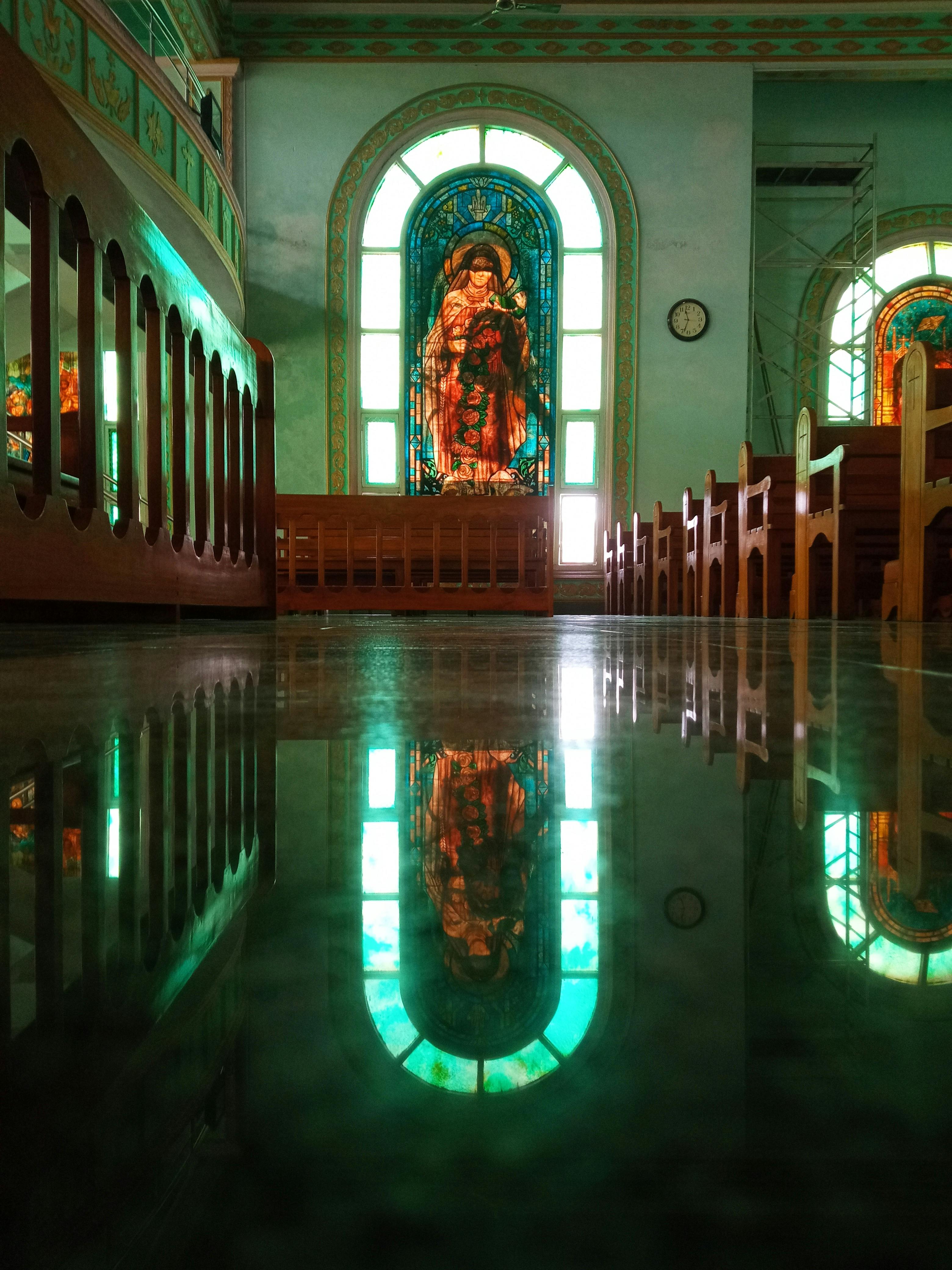 Stained-Glass Windown Mirroring in Floor of Church · Free Stock Photo