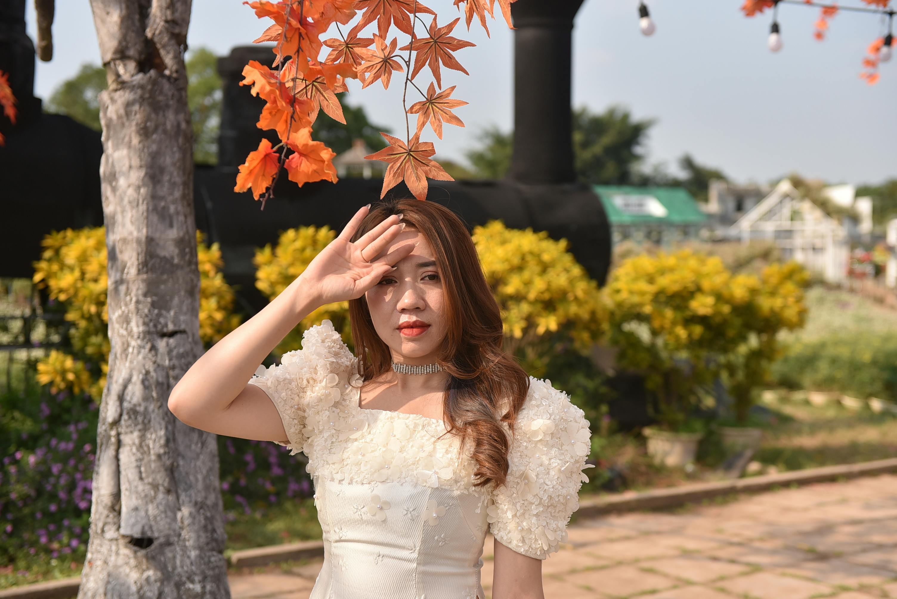 Brunette Woman Standing under Maple Tree in Autumn · Free Stock Photo