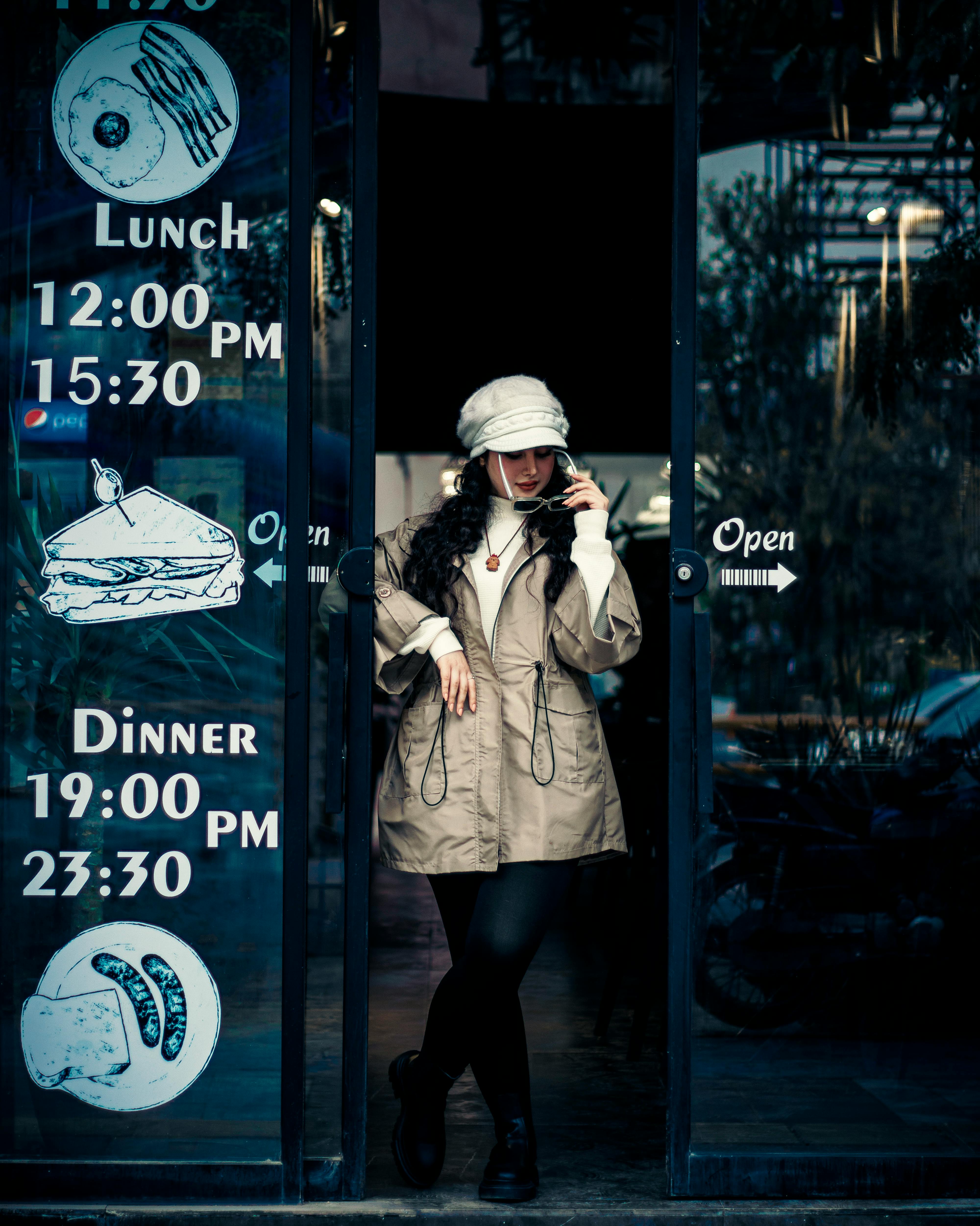 Woman in Hat and Jacket Leaving Restaurant · Free Stock Photo